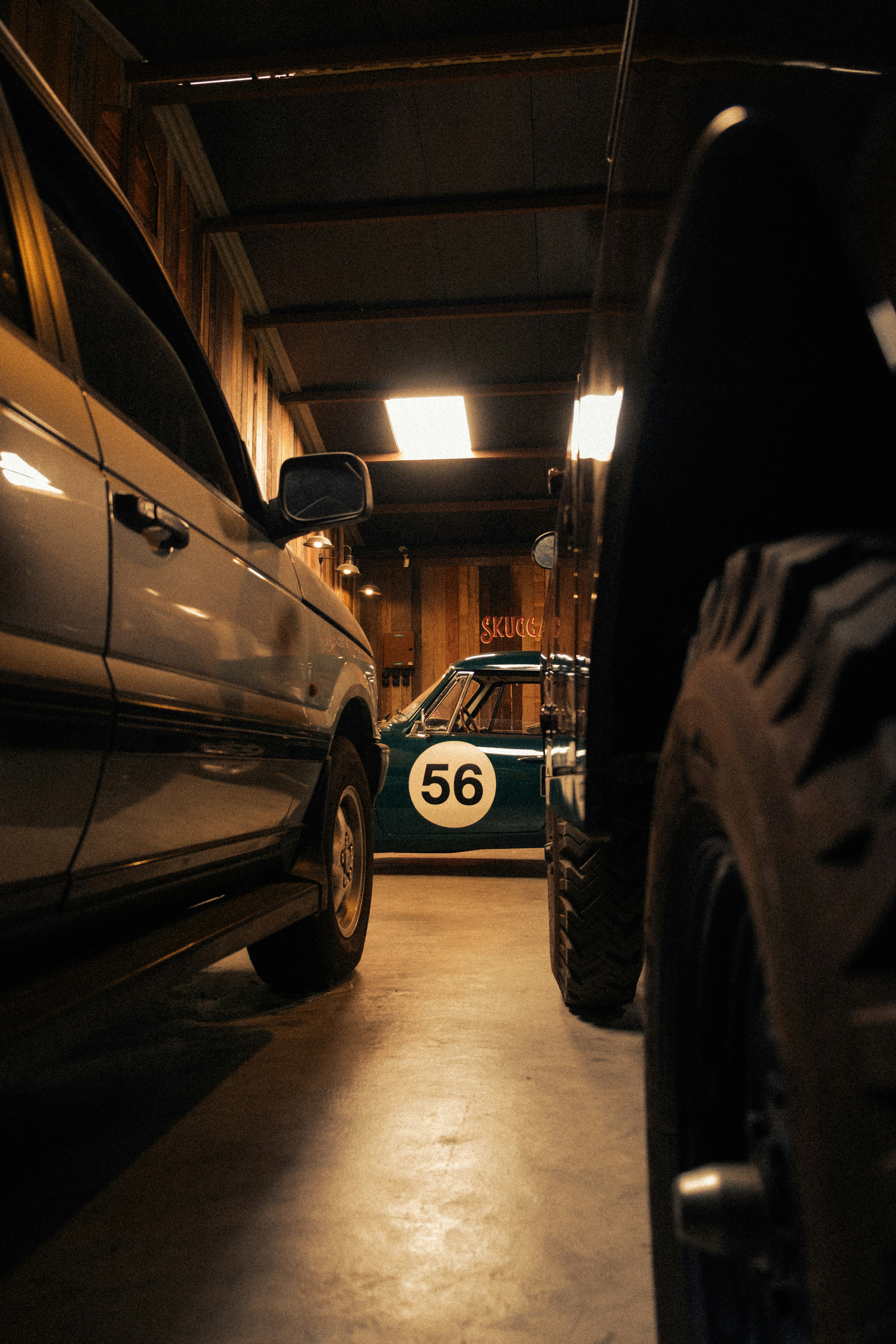 A Race-Ready Parking Garage: Classic Car Number 56 Emerges from the Shadowed Rows