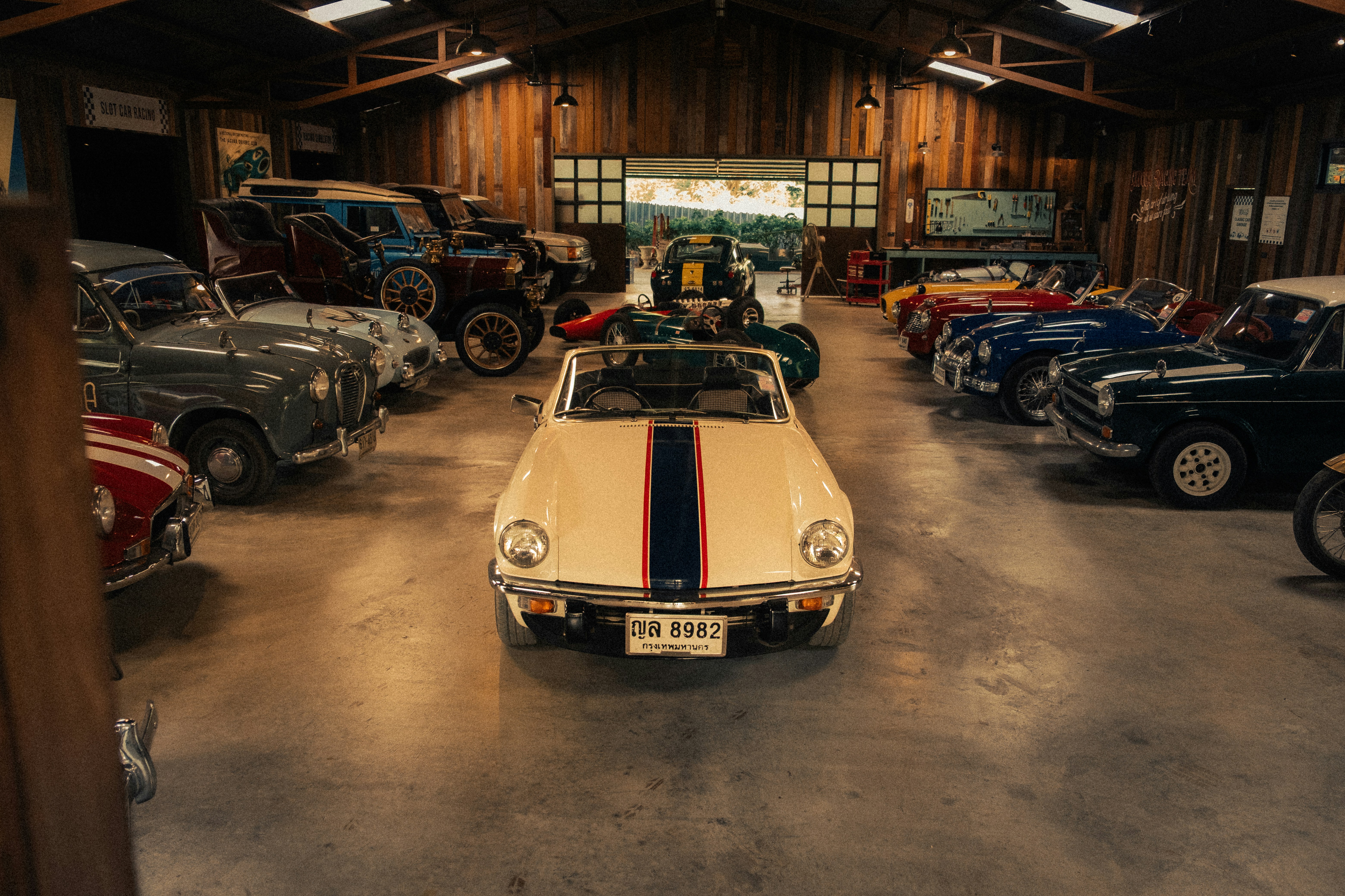 Centerstage Classic: A Vintage Convertible Surrounded by Restored Relics