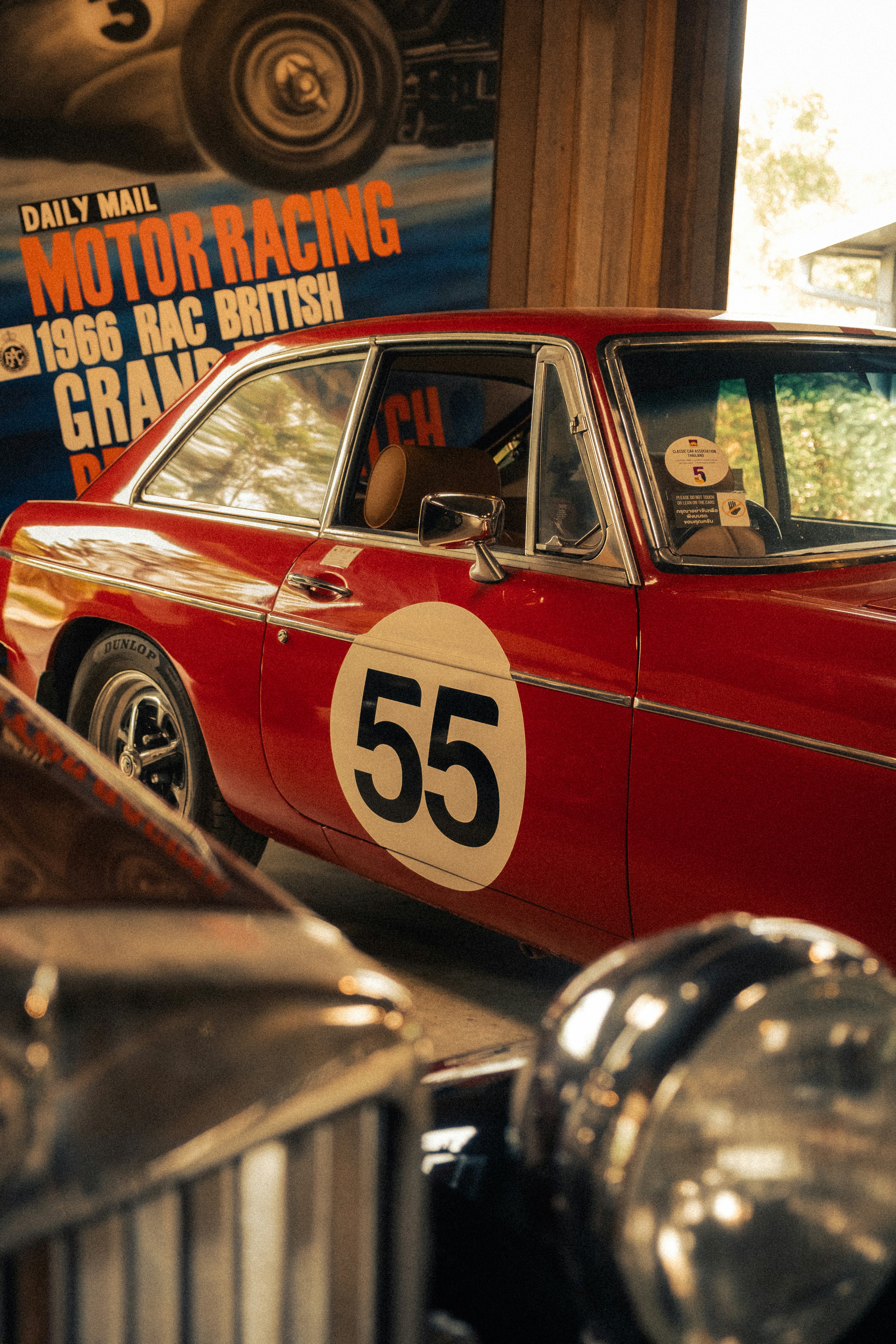 Red racing silhouette: vintage BMW tucked under a poster glow
