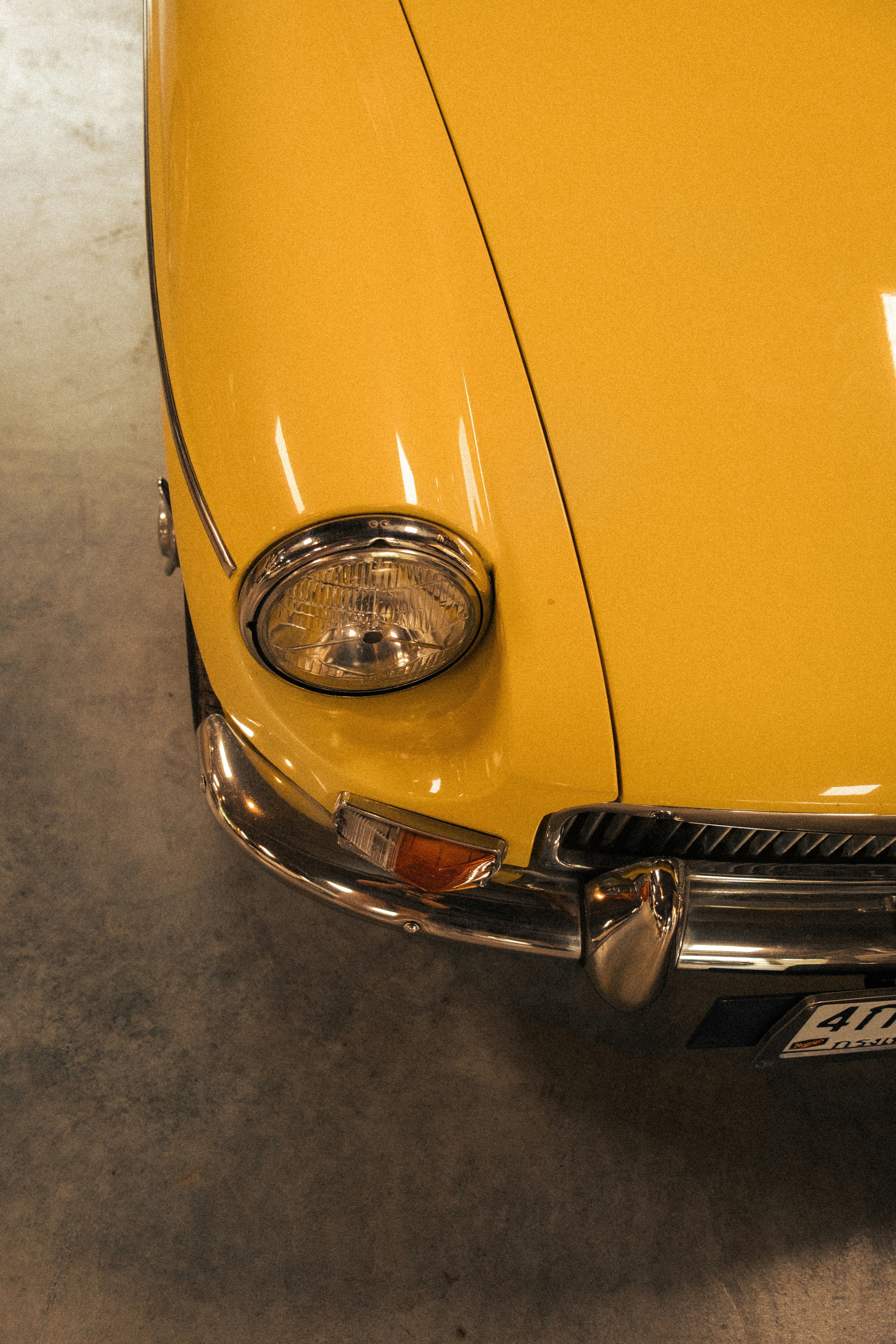 Yellow Vintage Car Hood and Headlight Welcome to the Showroom