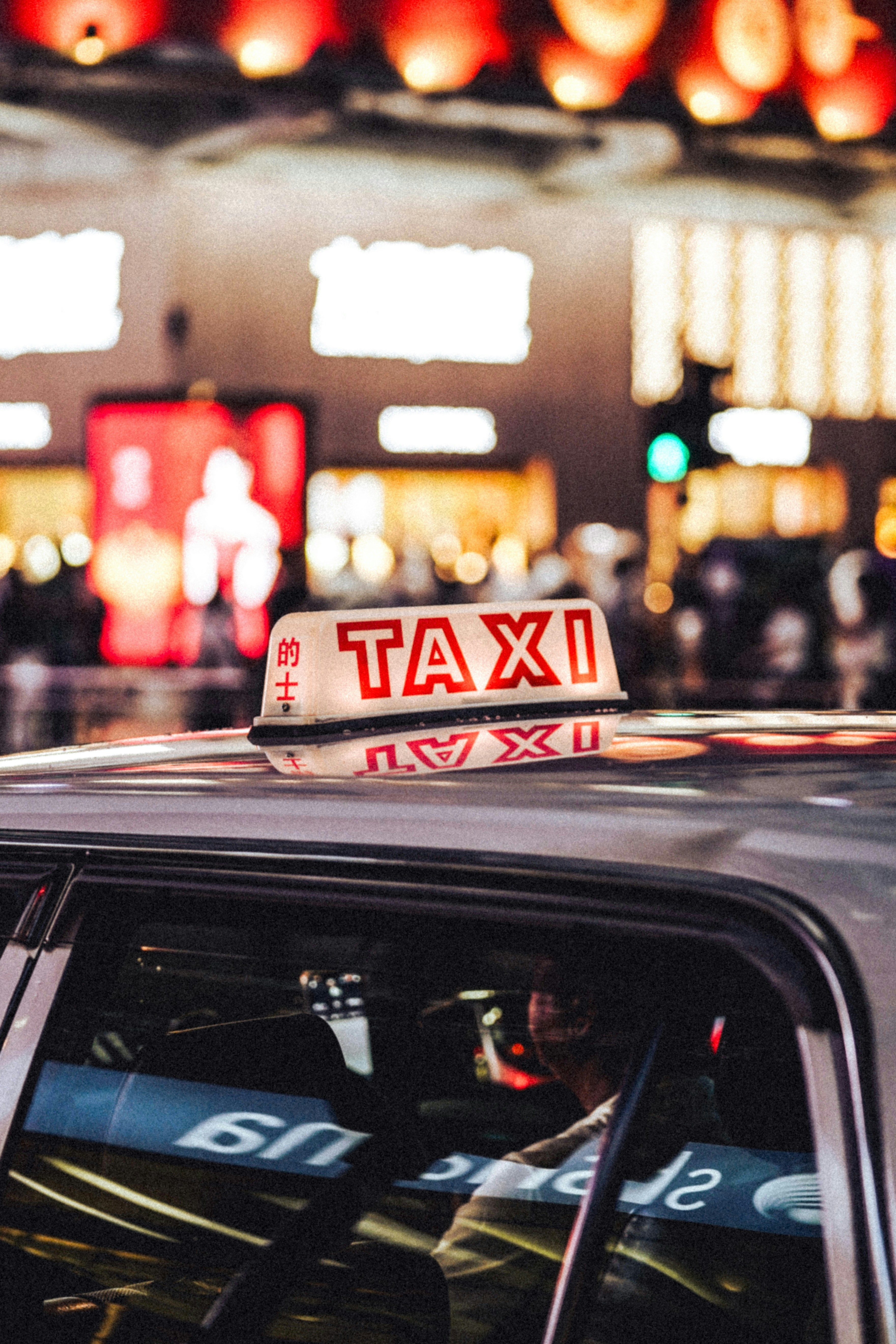 Taxi Sign Crowned in Neon Blur