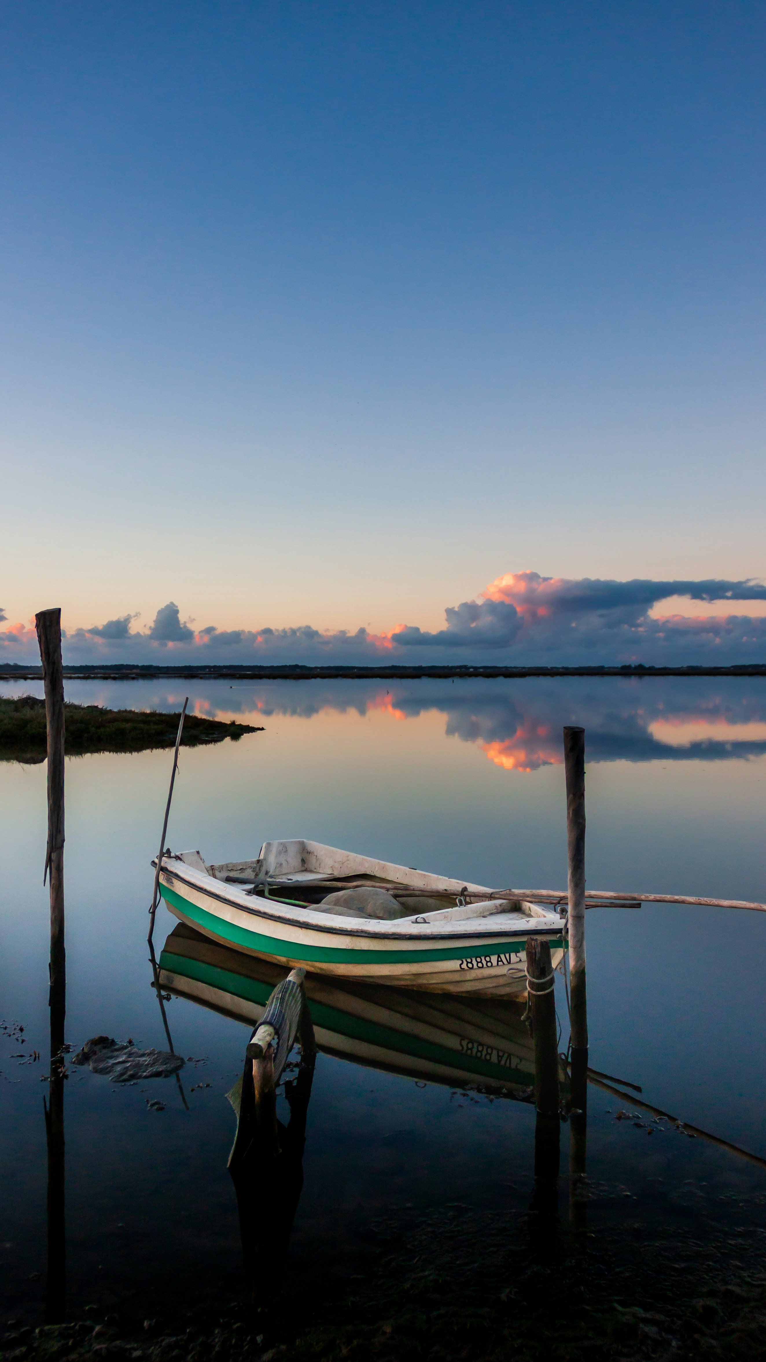 Boat at Dawn: A Quiet Shore Reflecting a Painted Sky