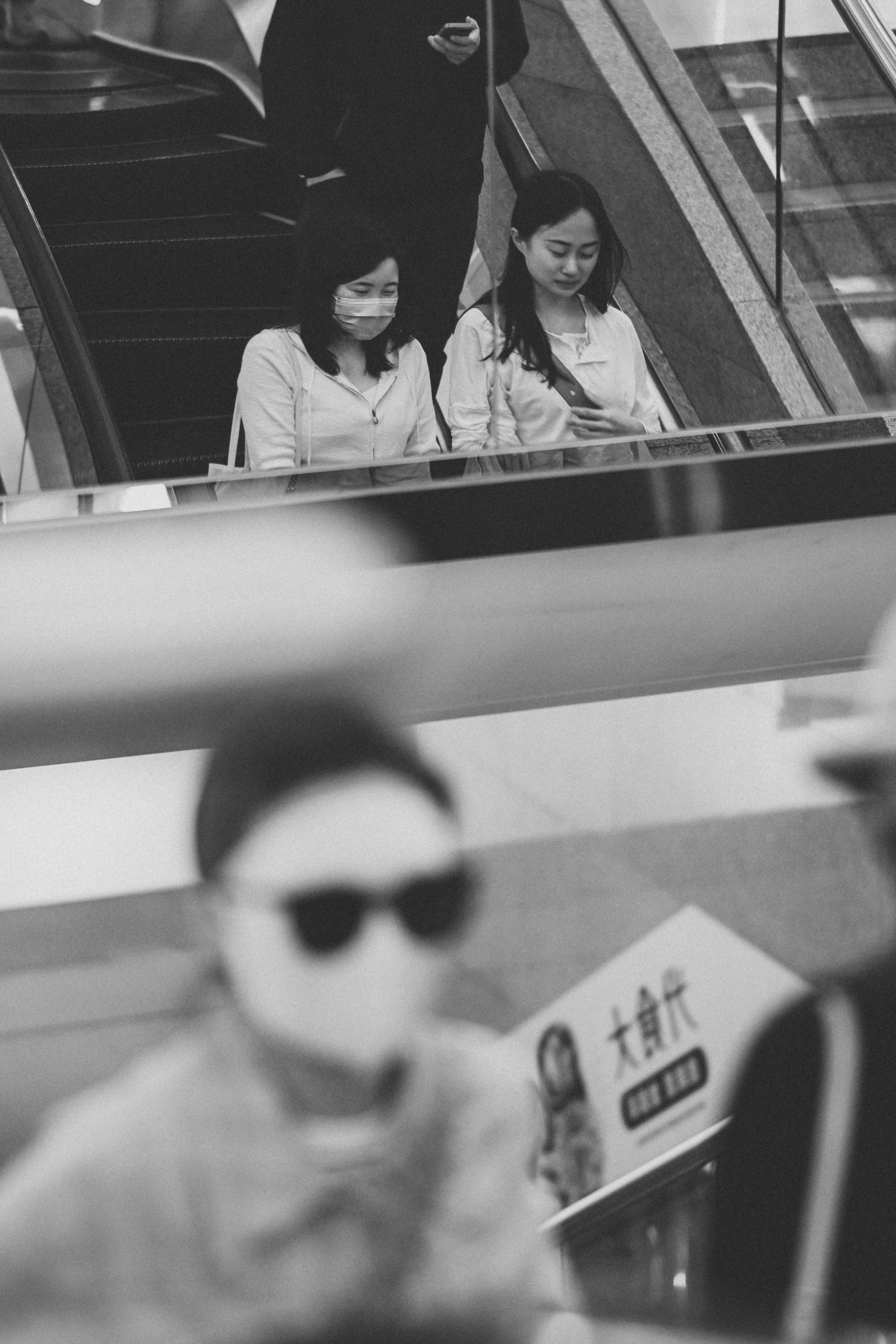 Across the Moving Walk: Quiet Intimacy Amid Blur