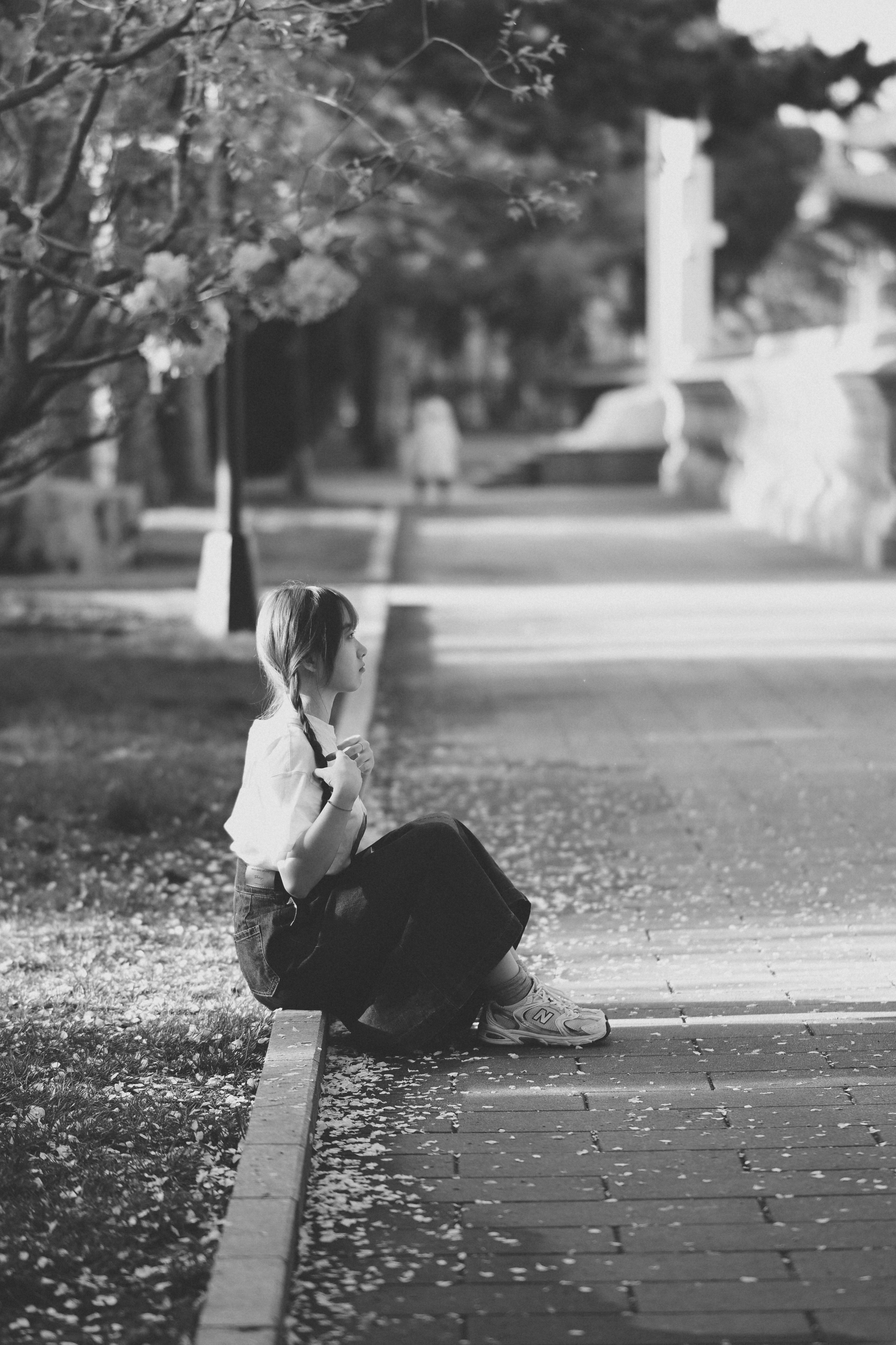 A Quiet Resolve: Girl with Braids on a Sunlit Path