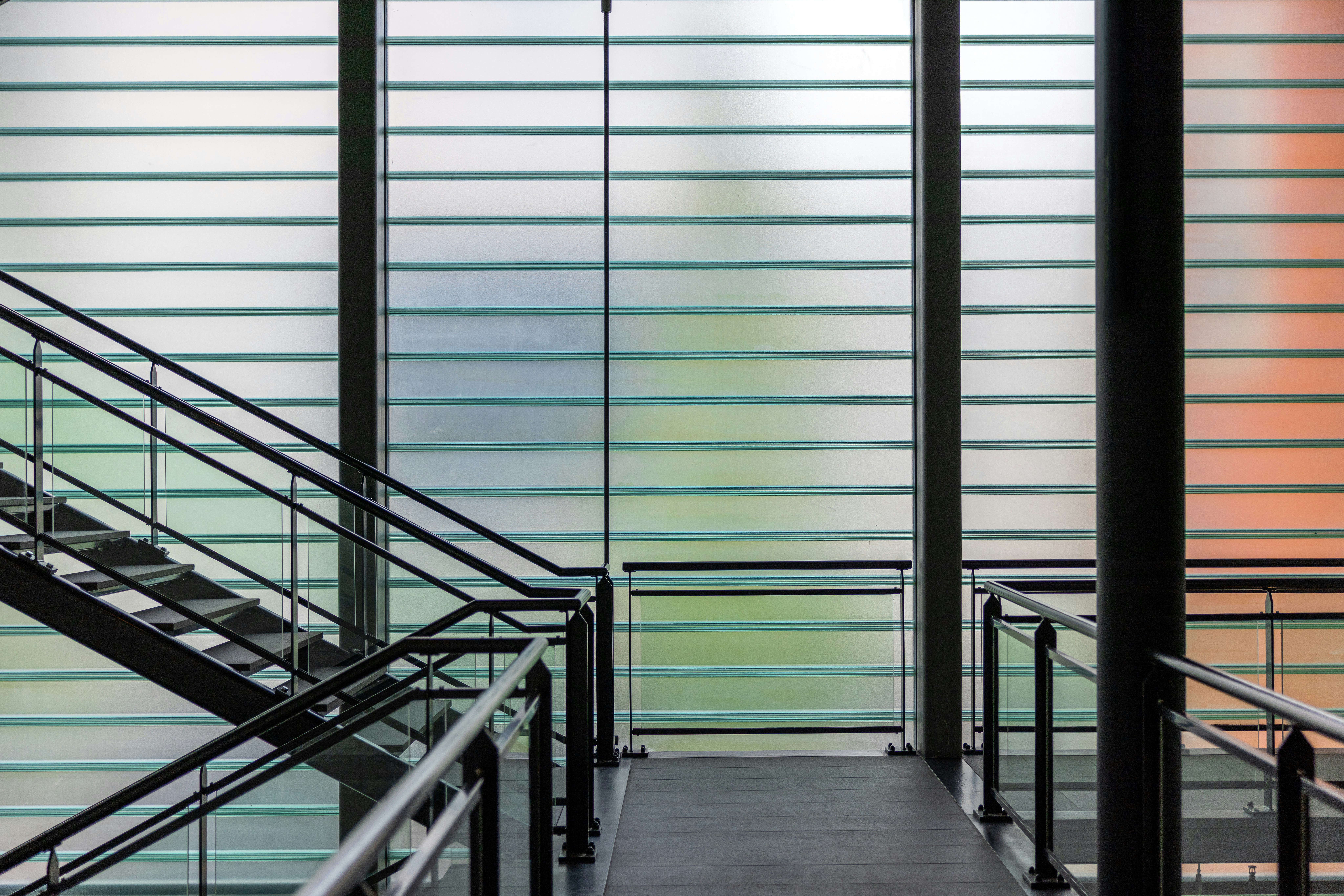 Glassy Corridor: Symmetry and Stairs in a Modern Atrium