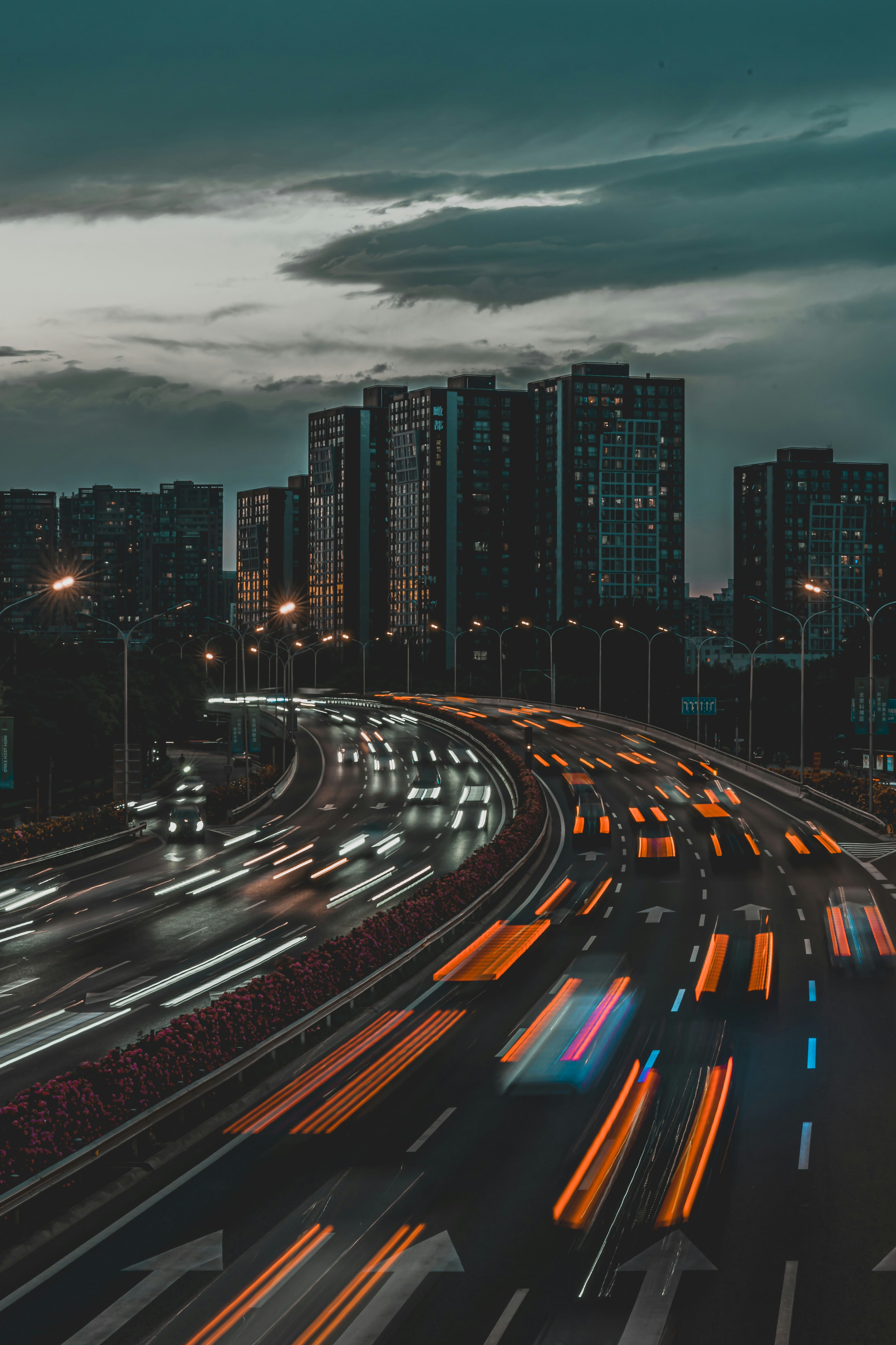 Midnight Pulse: Neon Trails Over the Curving Urban Highway