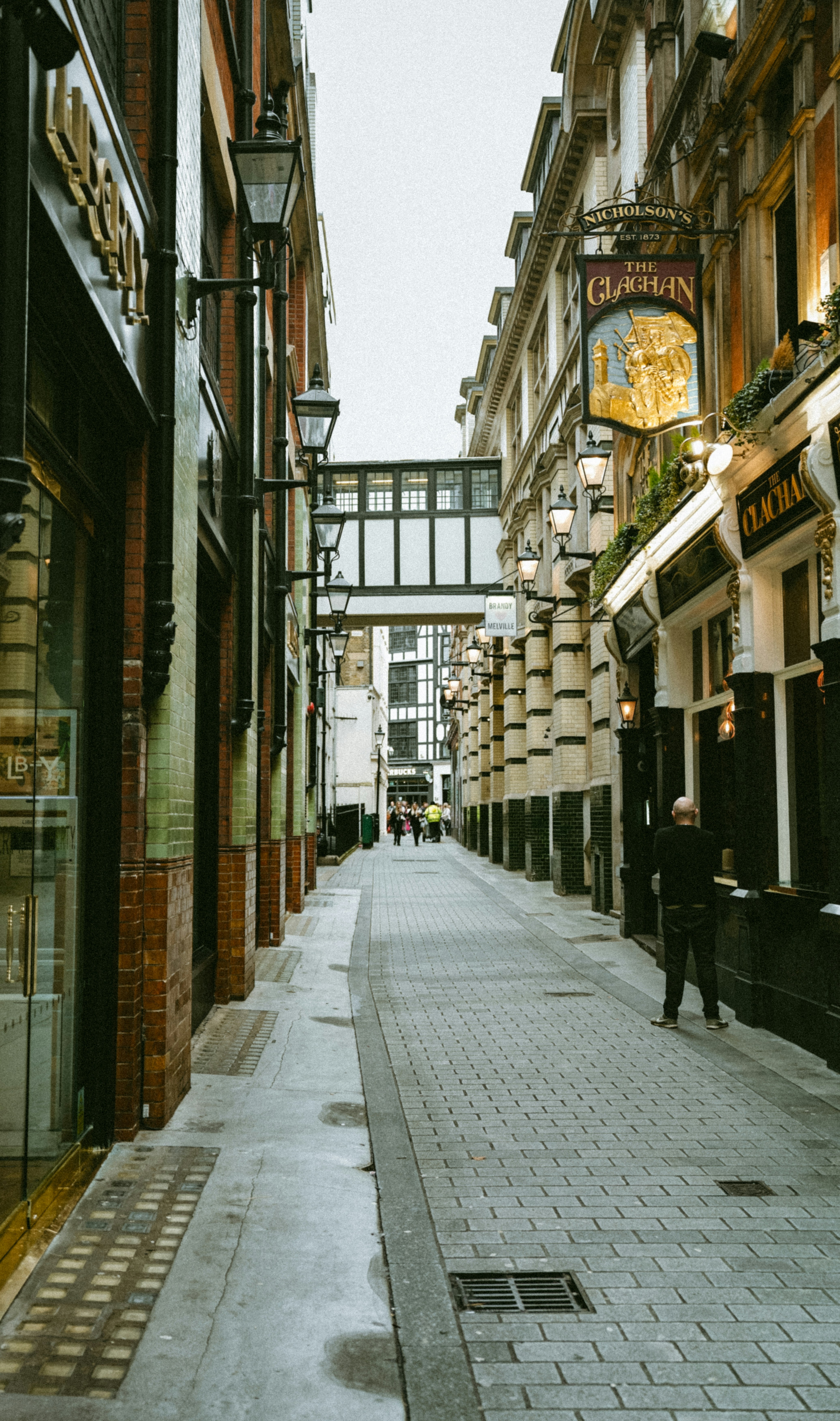 Alleyway Bridge to a Historic Pub Lane