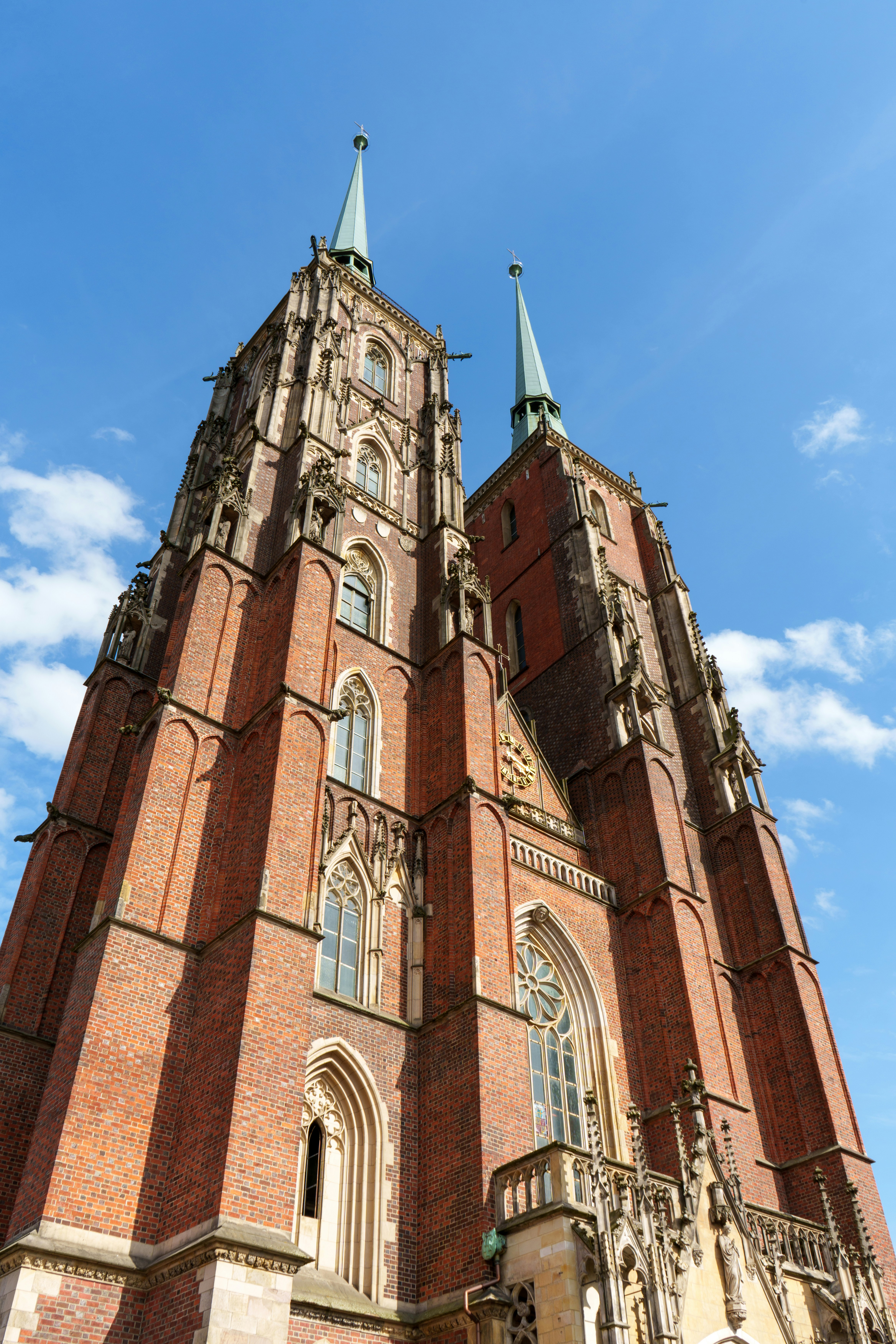 Gothic Brick Towers Piercing a Blue Sky