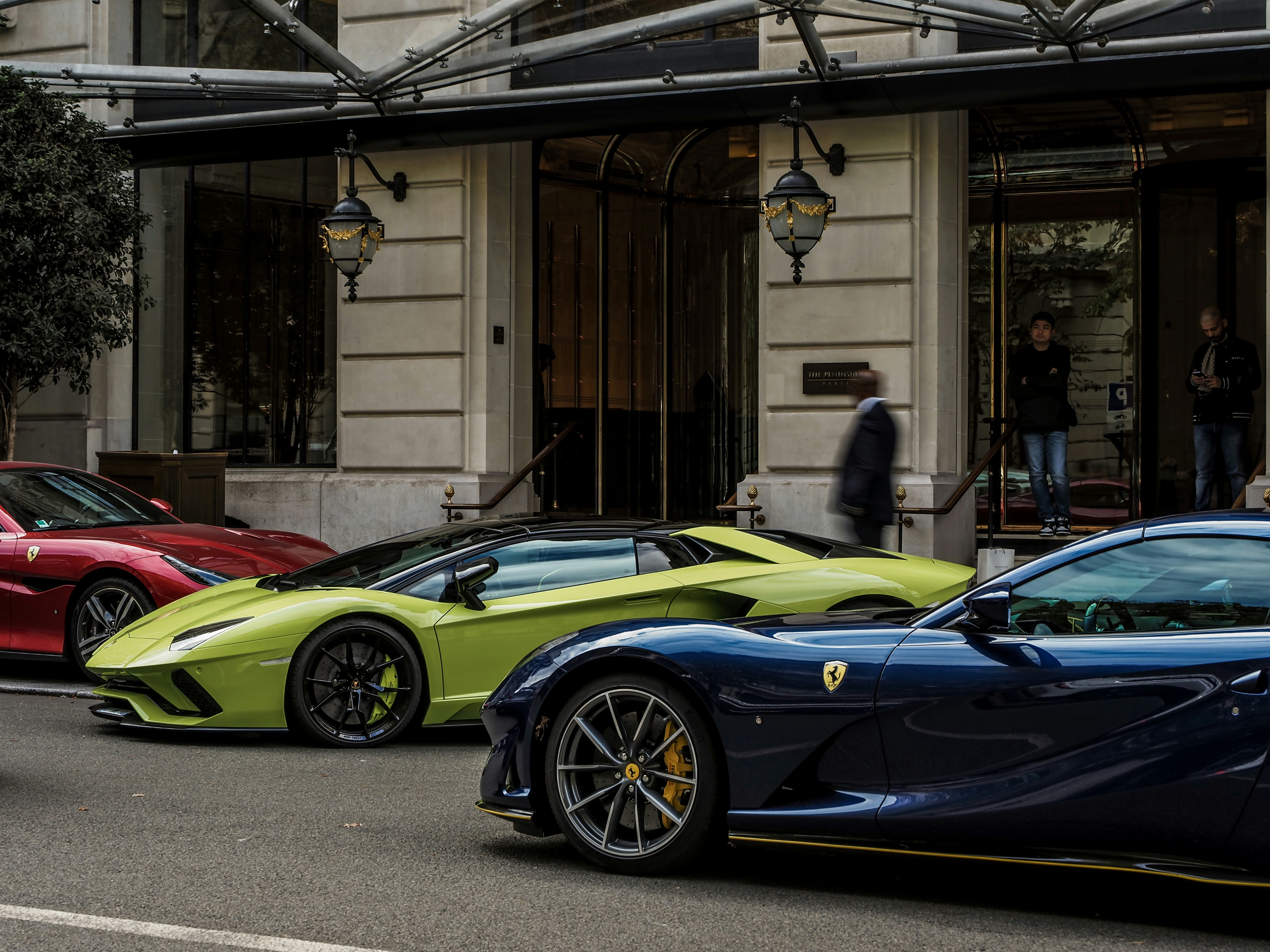 Neon Green and Midnight Blue: Supercars Stretch Along a Parisian Facade