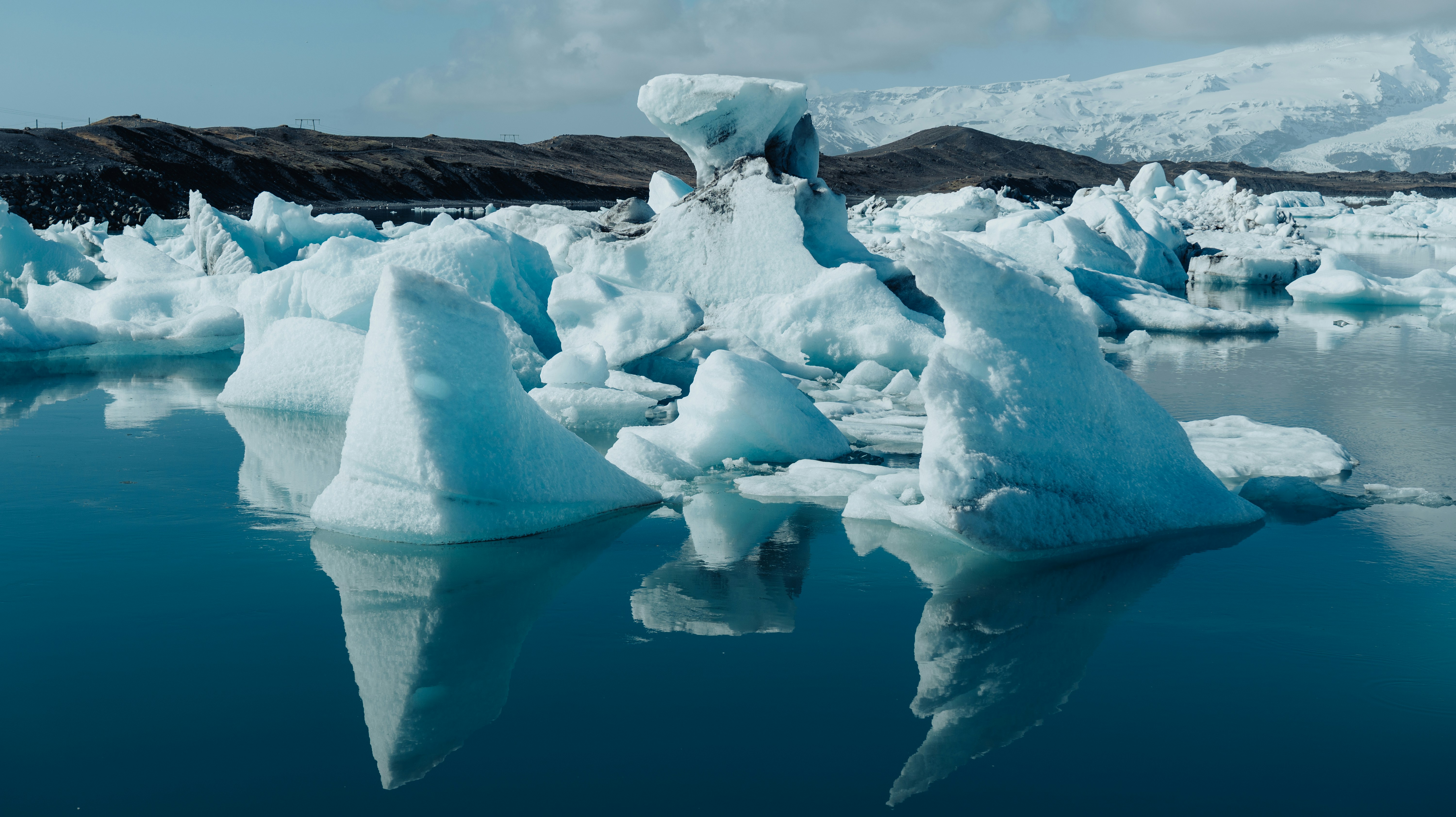 Icebound Monoliths: Sparse Peaks Rippling on a Glassy Fjord
