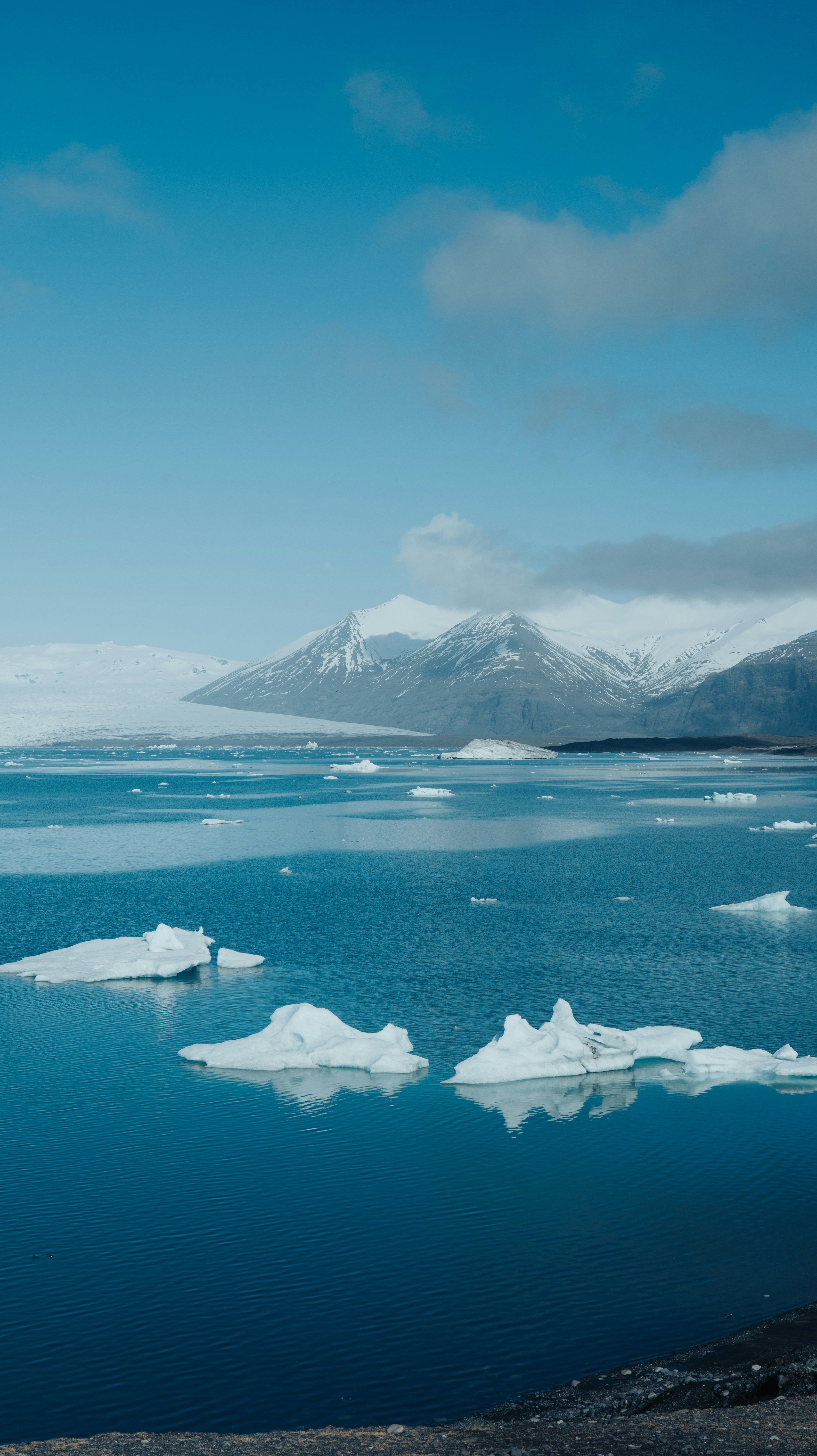 Glacial Horizon: Ice Floes Drift Under Open Arctic Sky