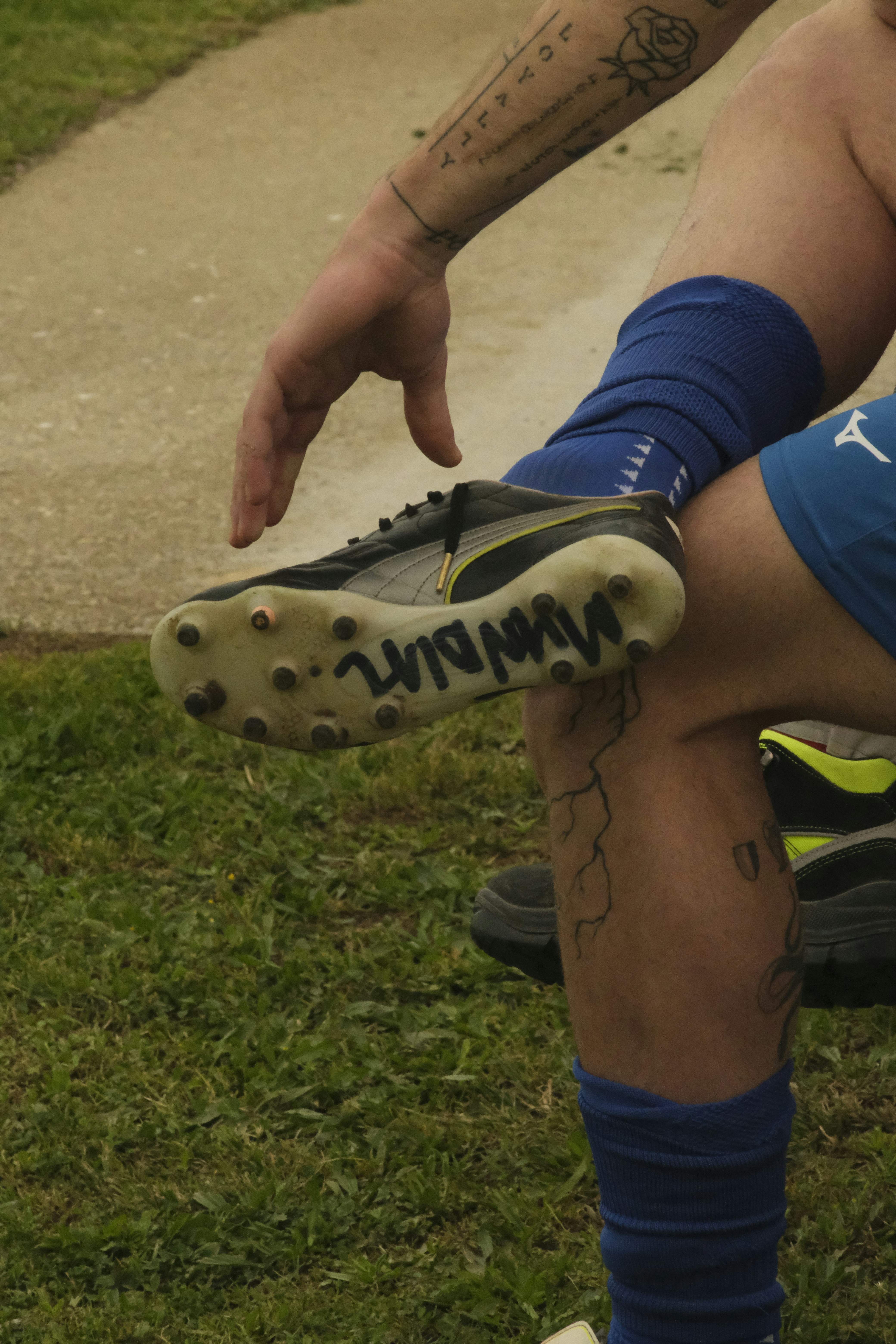 Mud-Splashed Kick: A Moment of Contact in a Grass-Field Duel