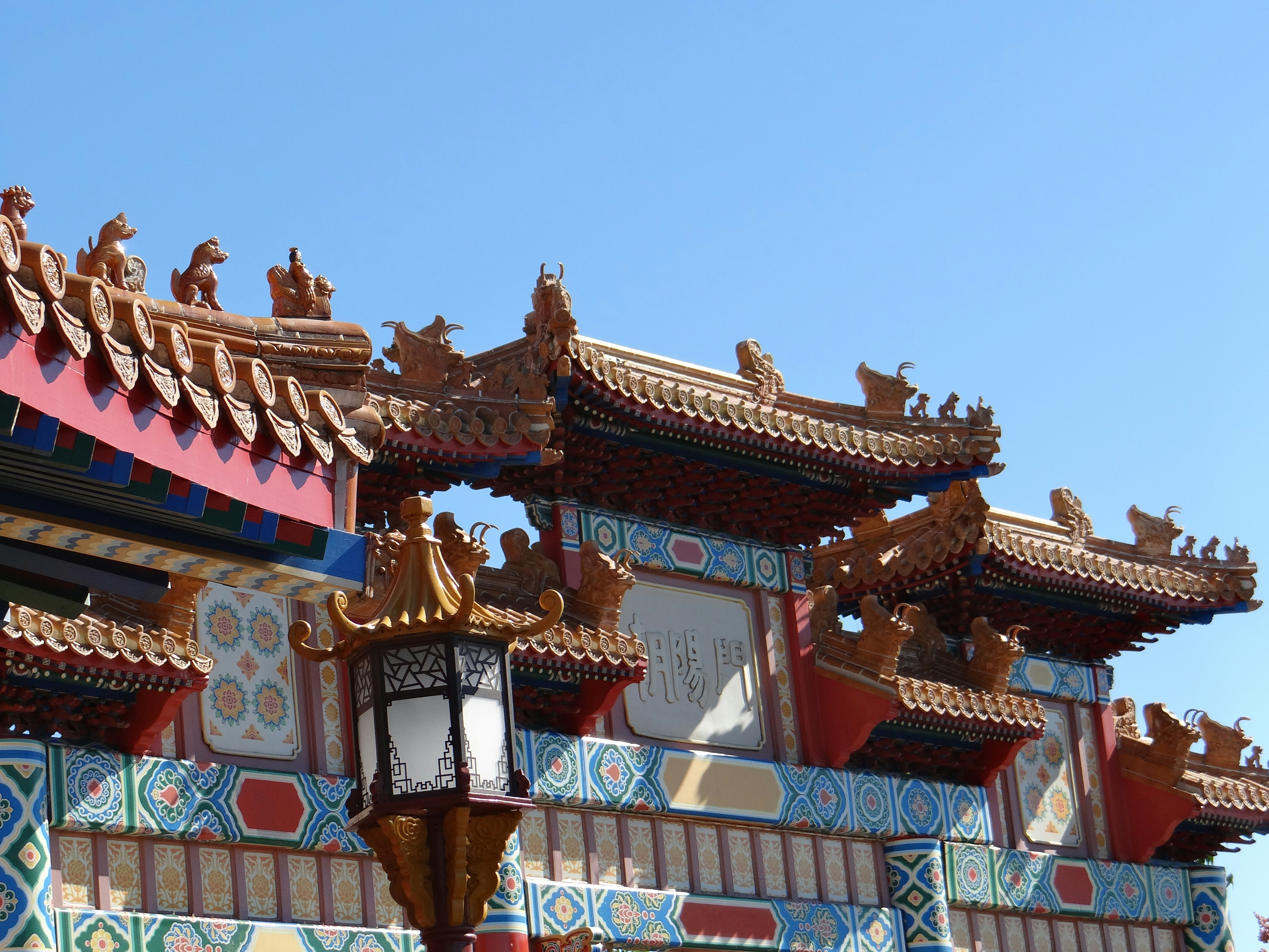 Carved Dragons and Fragrant Eaves: A Chinese Temple Roof in Bright Daylight