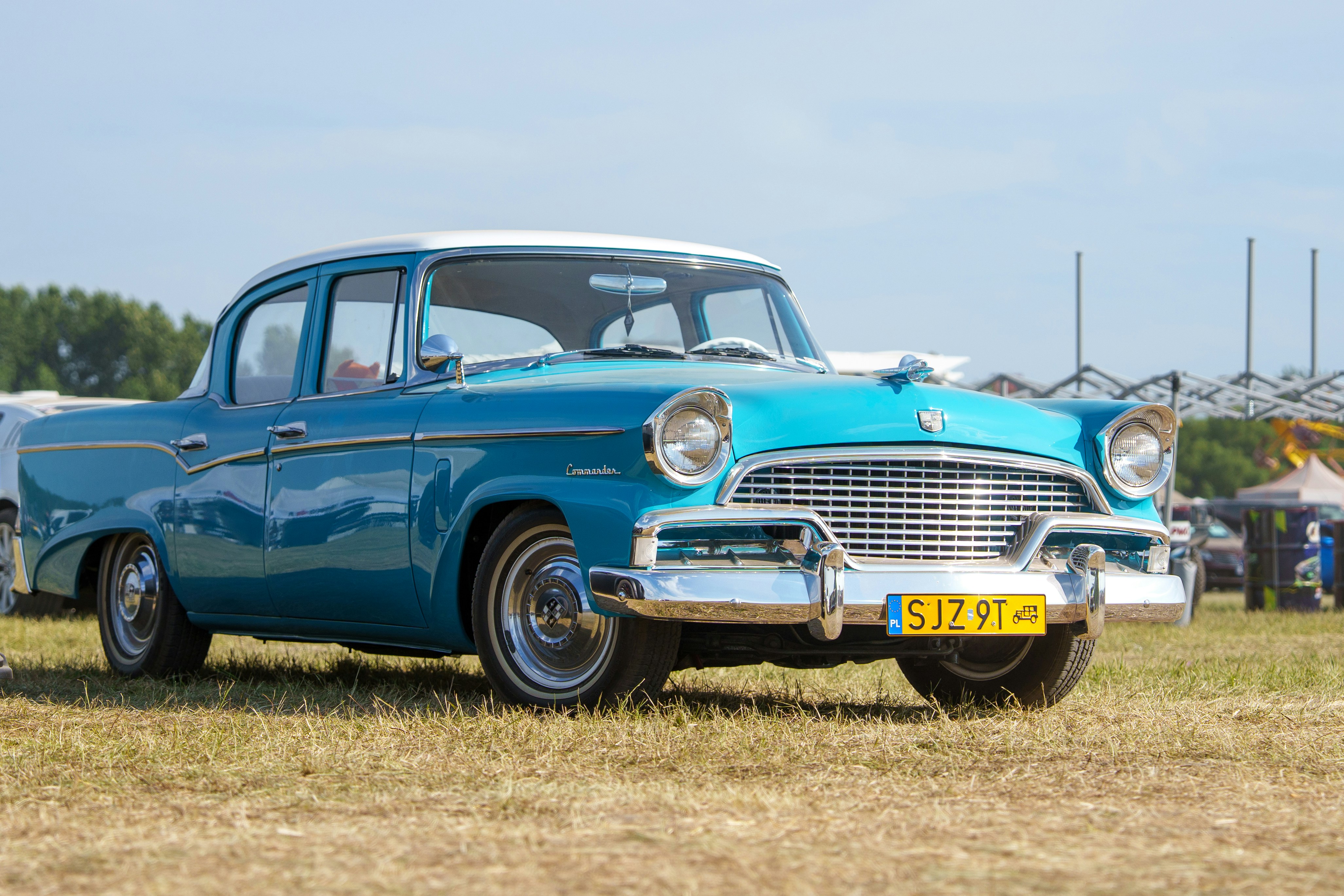 Azure Classic: A Vintage Chevrolet Streaking Across a Sunlit Field