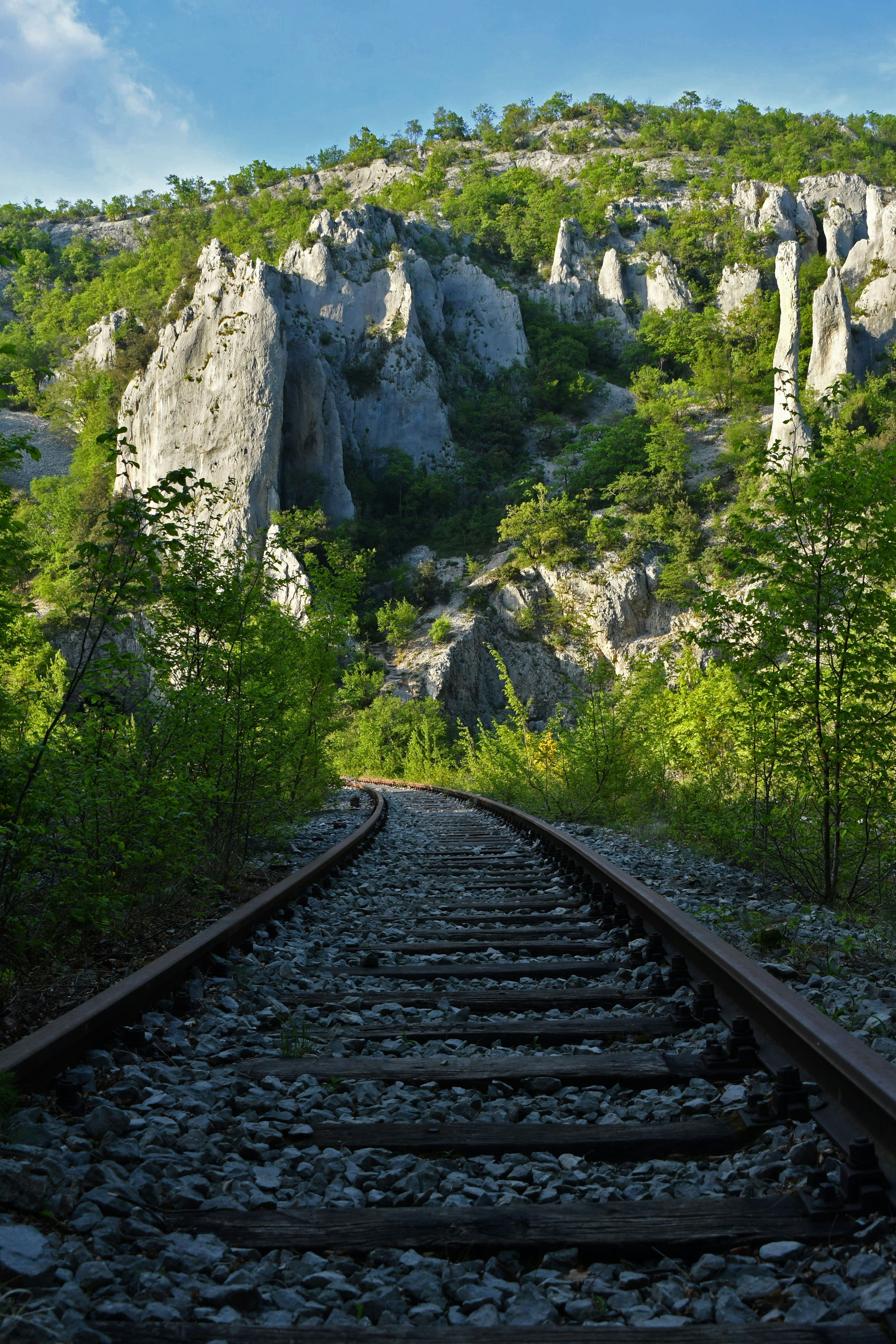 Rail toward the limestone cliffs