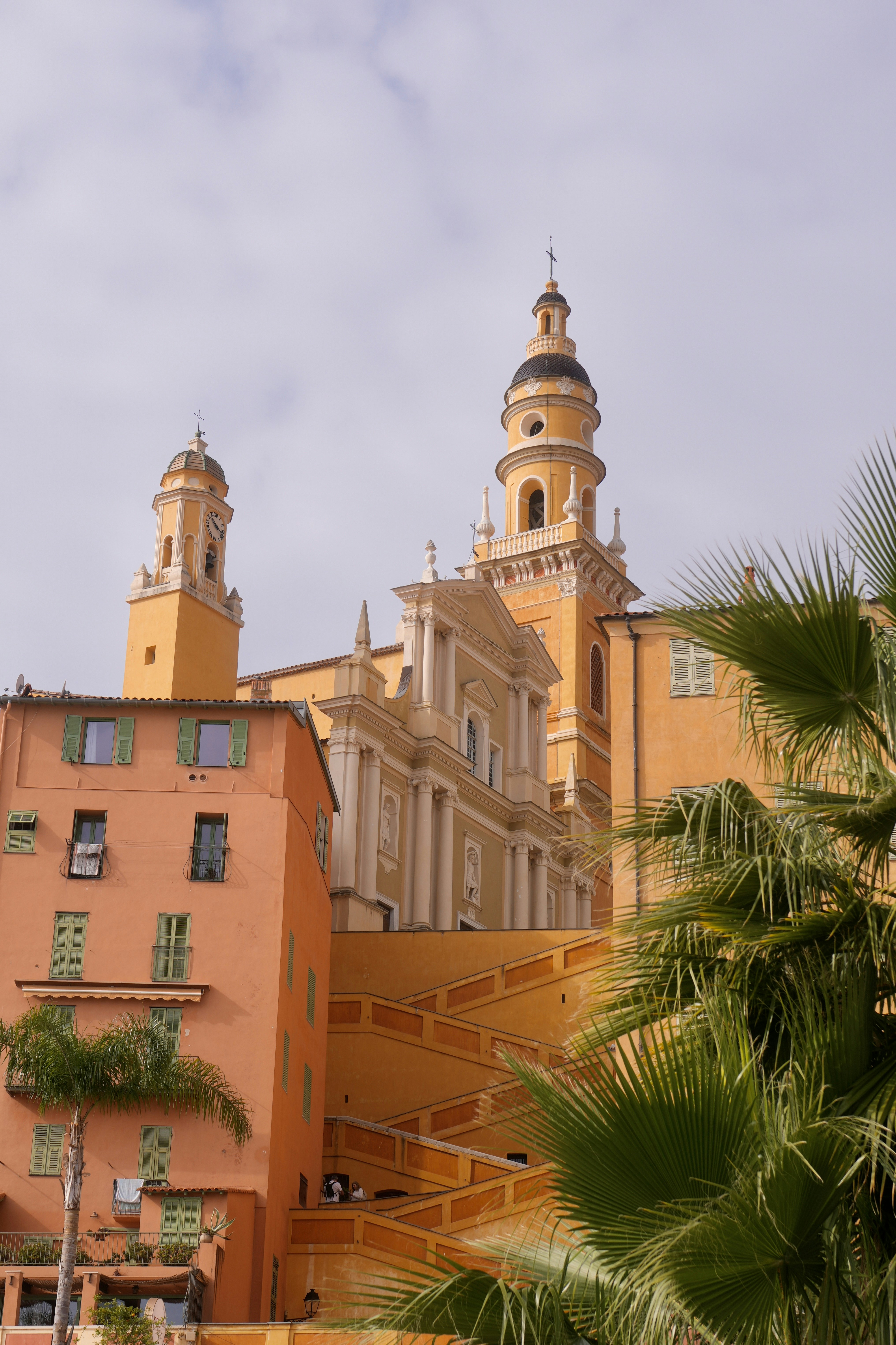 Sunlit Orange Sanctum: A Coastal Cathedral Rises Above Terracotta Steps