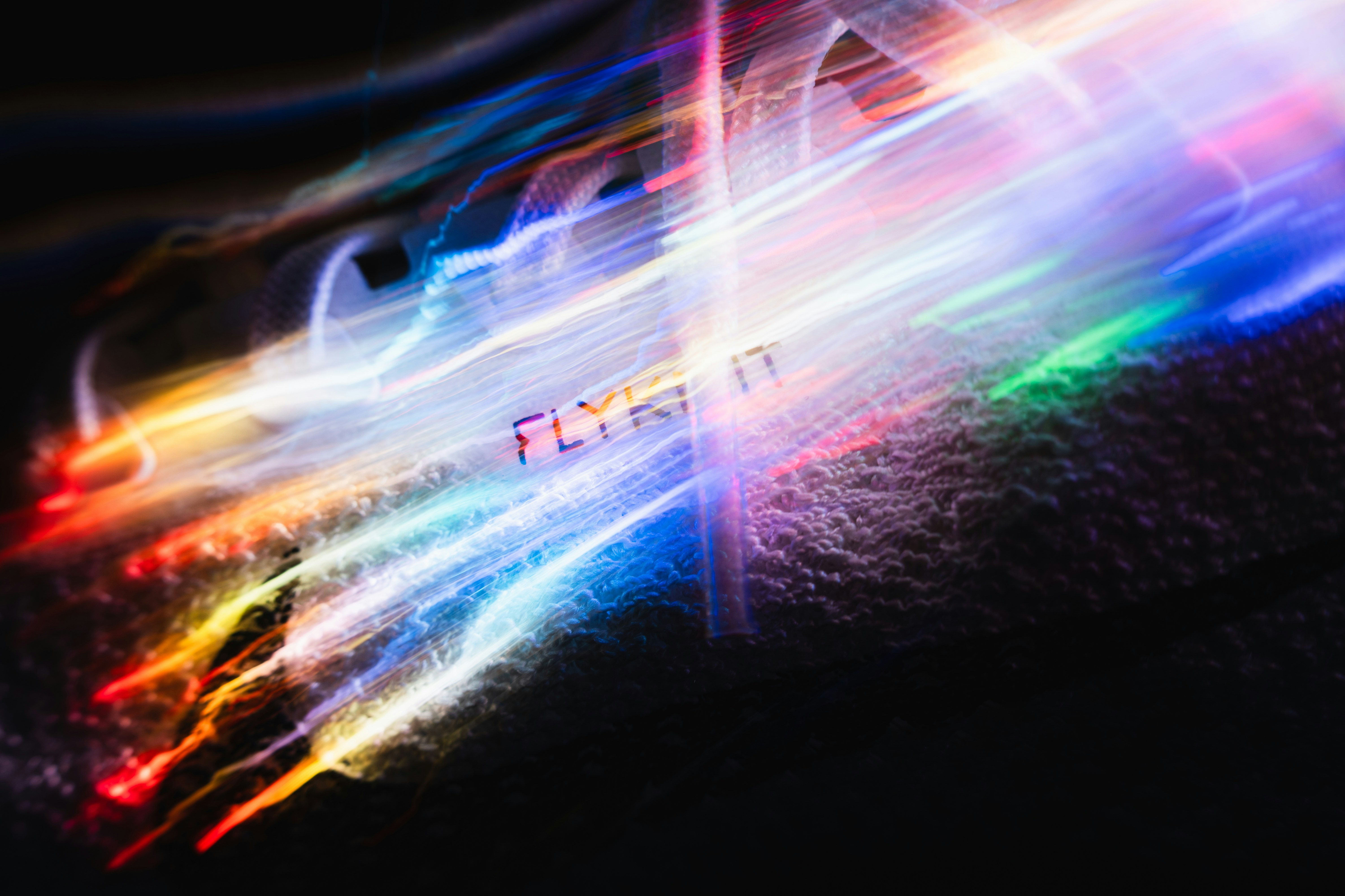 Neon Trails Across a Dark Asphalt Night
