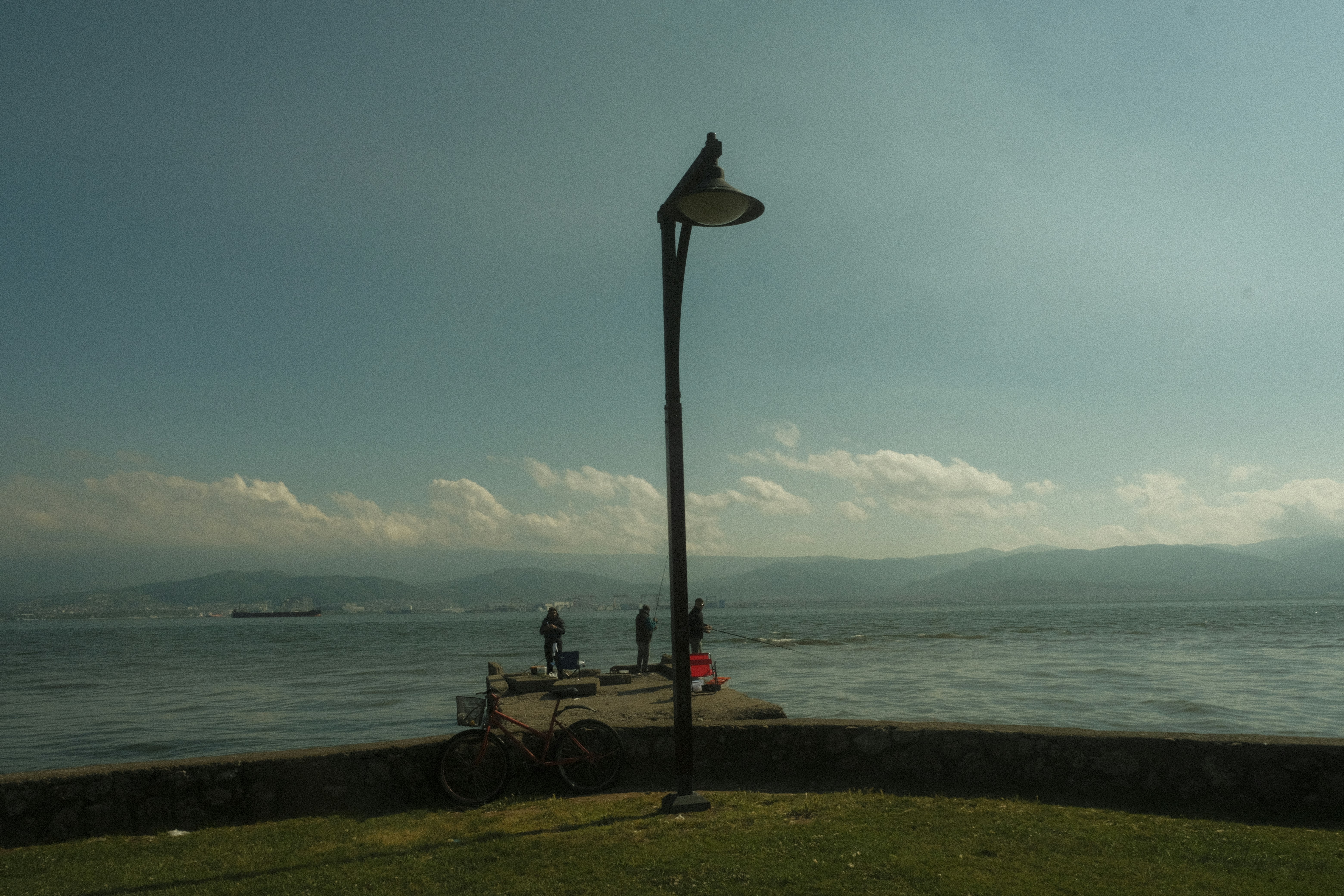 Lone Lamp Post Overlooking a Quiet Lakefront