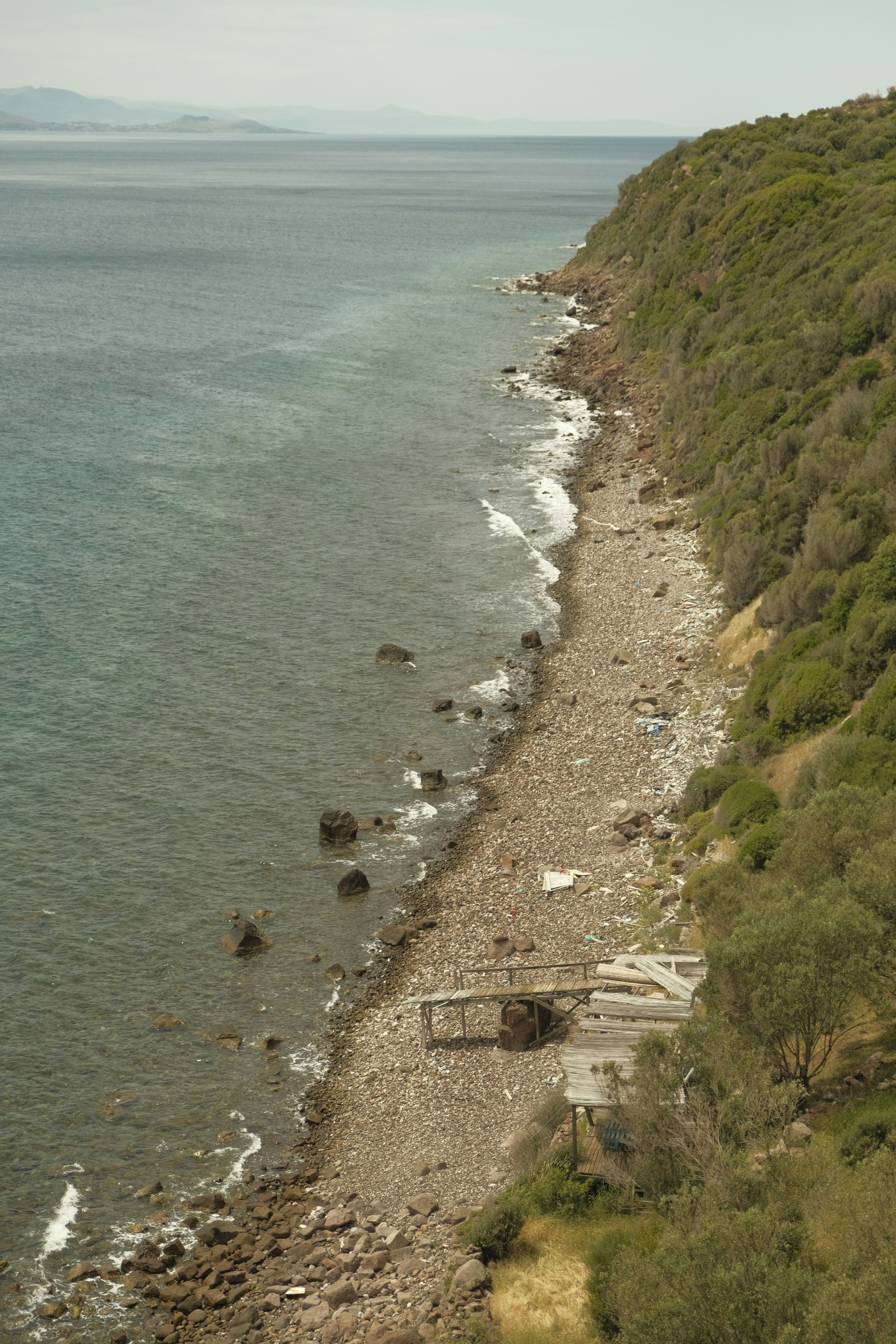 Shoreline Cliffline: A Secluded Pebble Beach along a Verdant Cliff