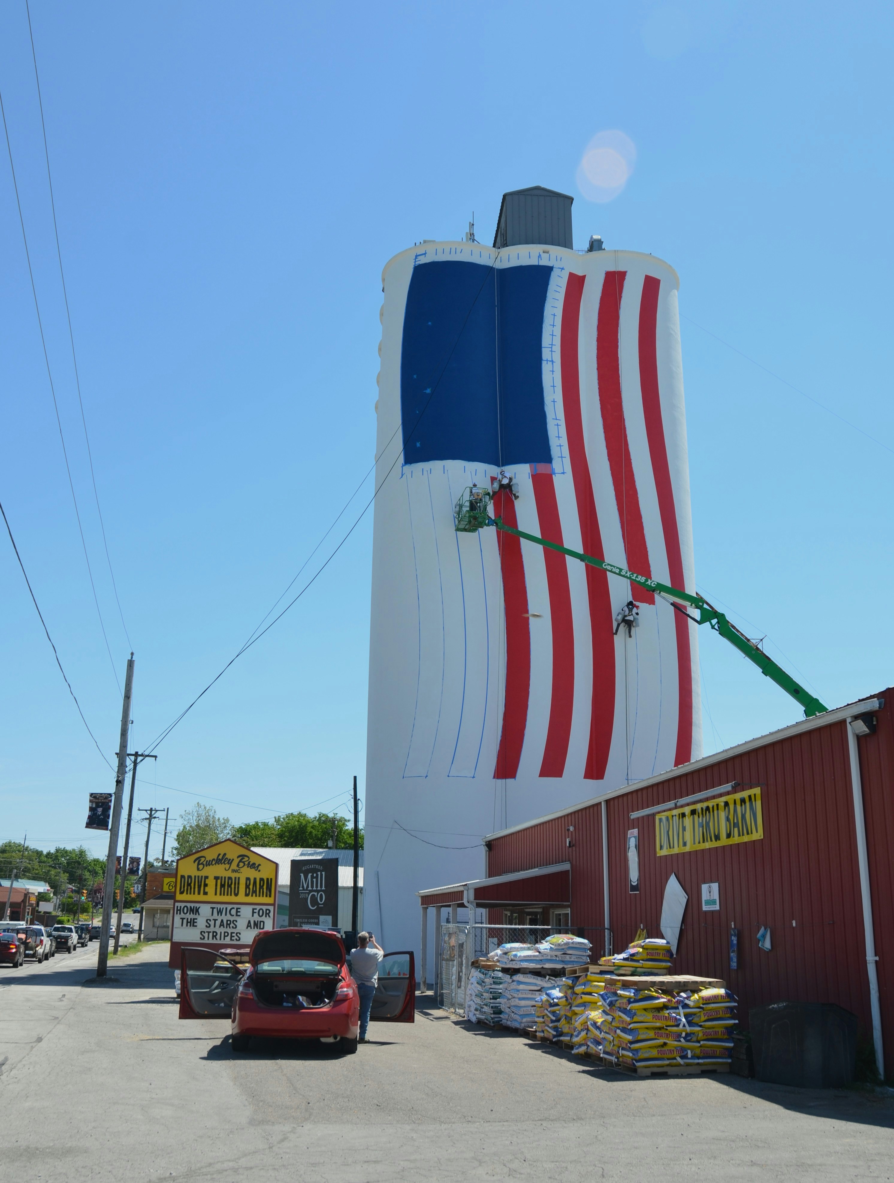 Giant American Flag Silkscreened Silotype Tower at a Lumber Yard