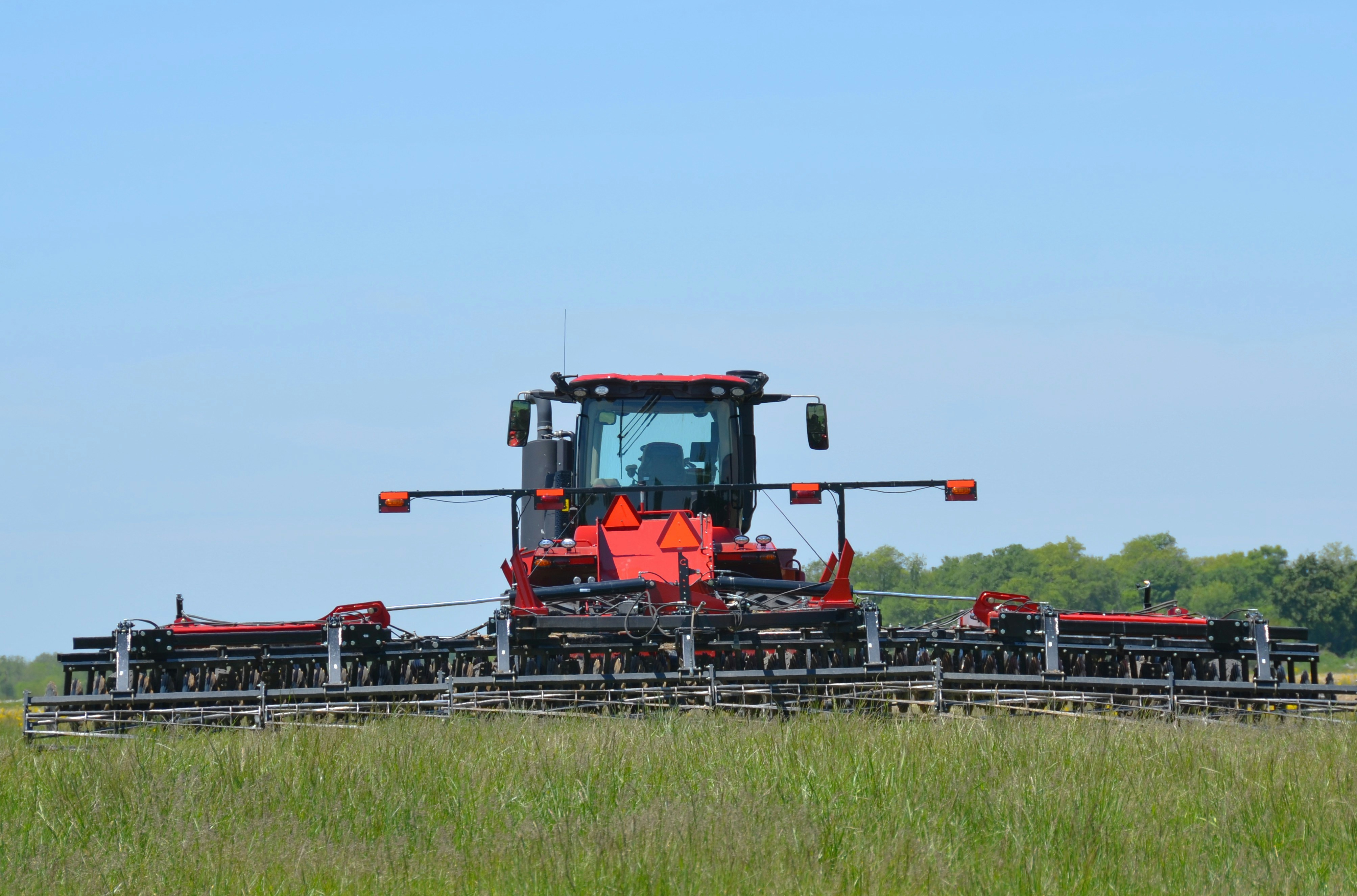 Front‑and‑center Harvester: Red Machinery in a Sunlit Field