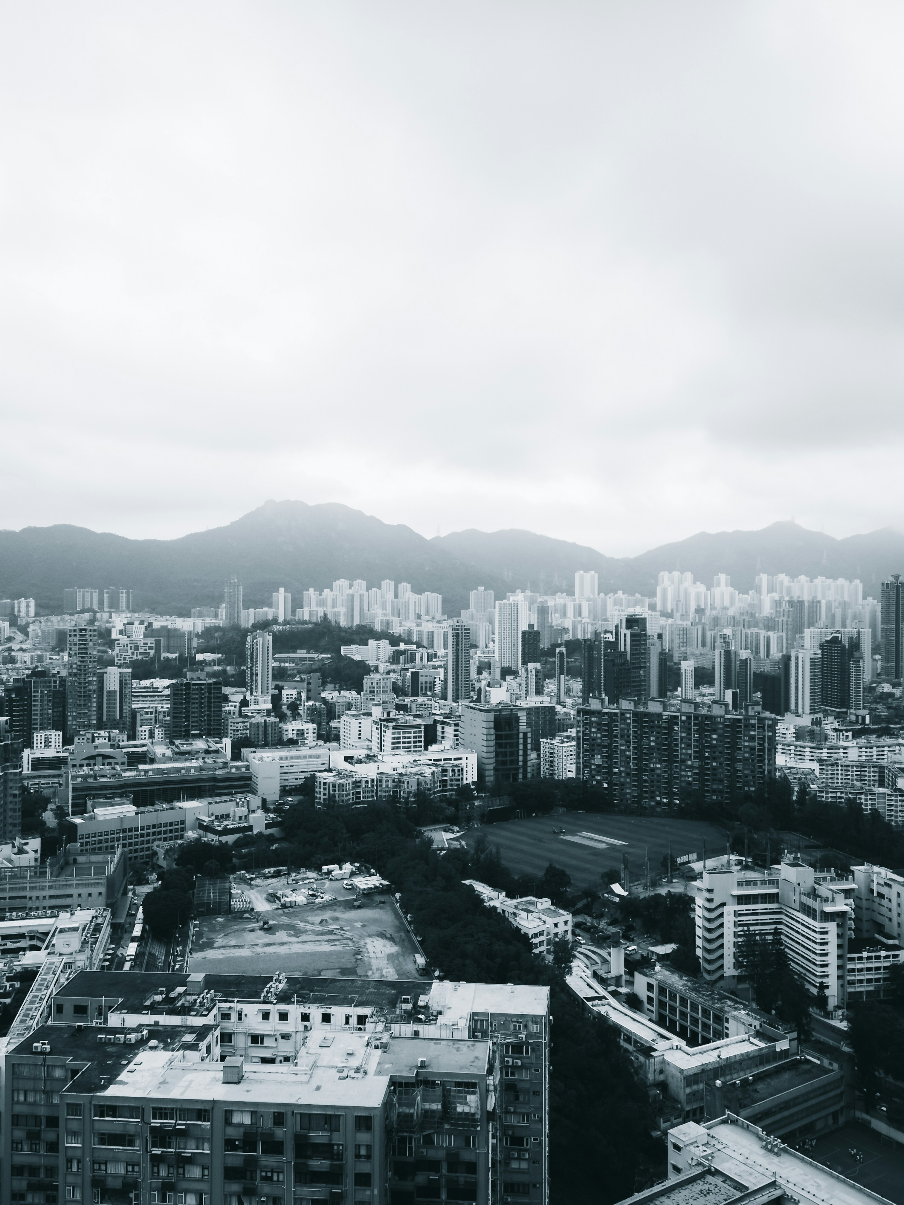 Urban Horizon: A Monochrome Cityscape Under Clouded Sky