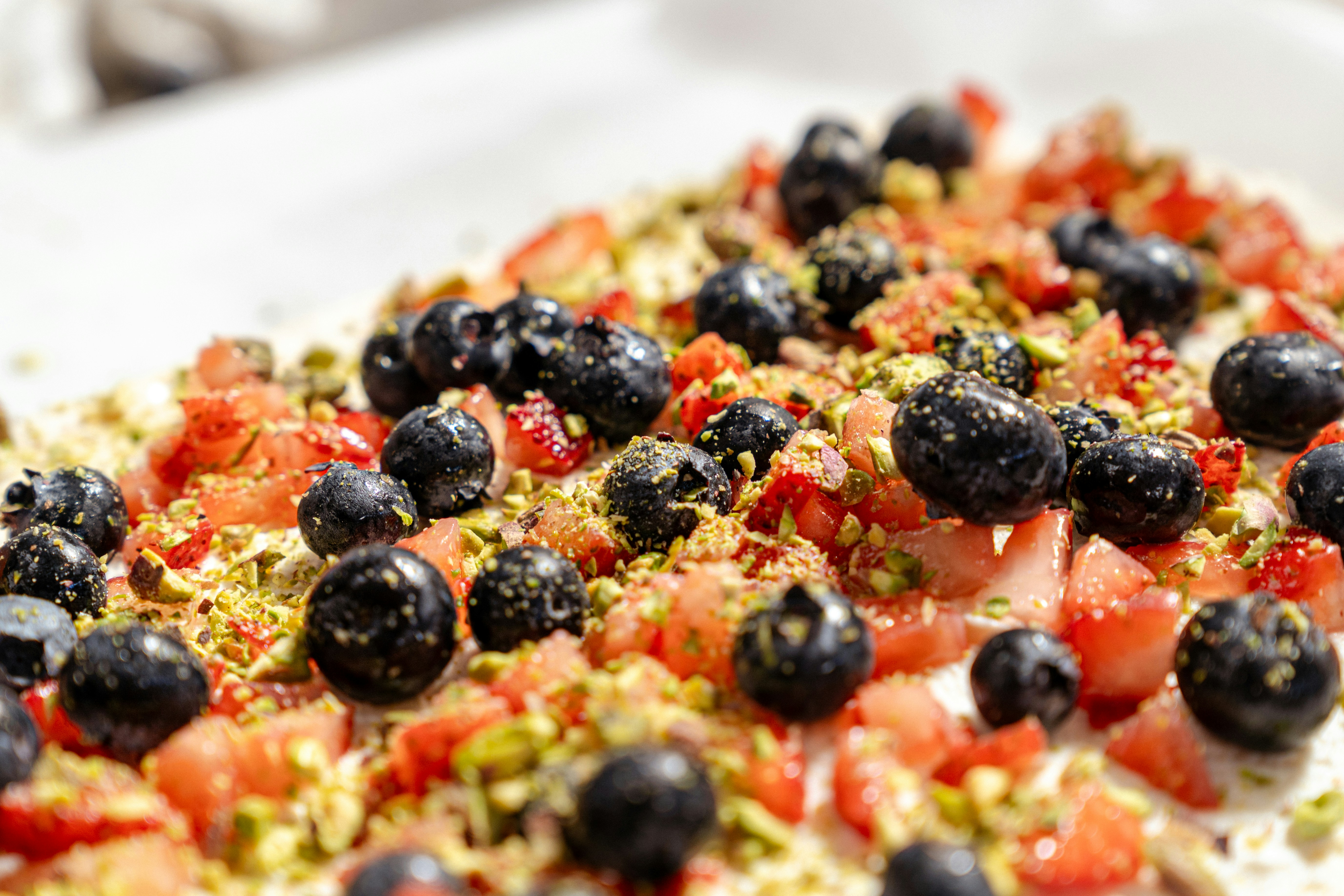 Berry Mosaic: A Close-Up of Fresh Fruit and Pistachio Crunch