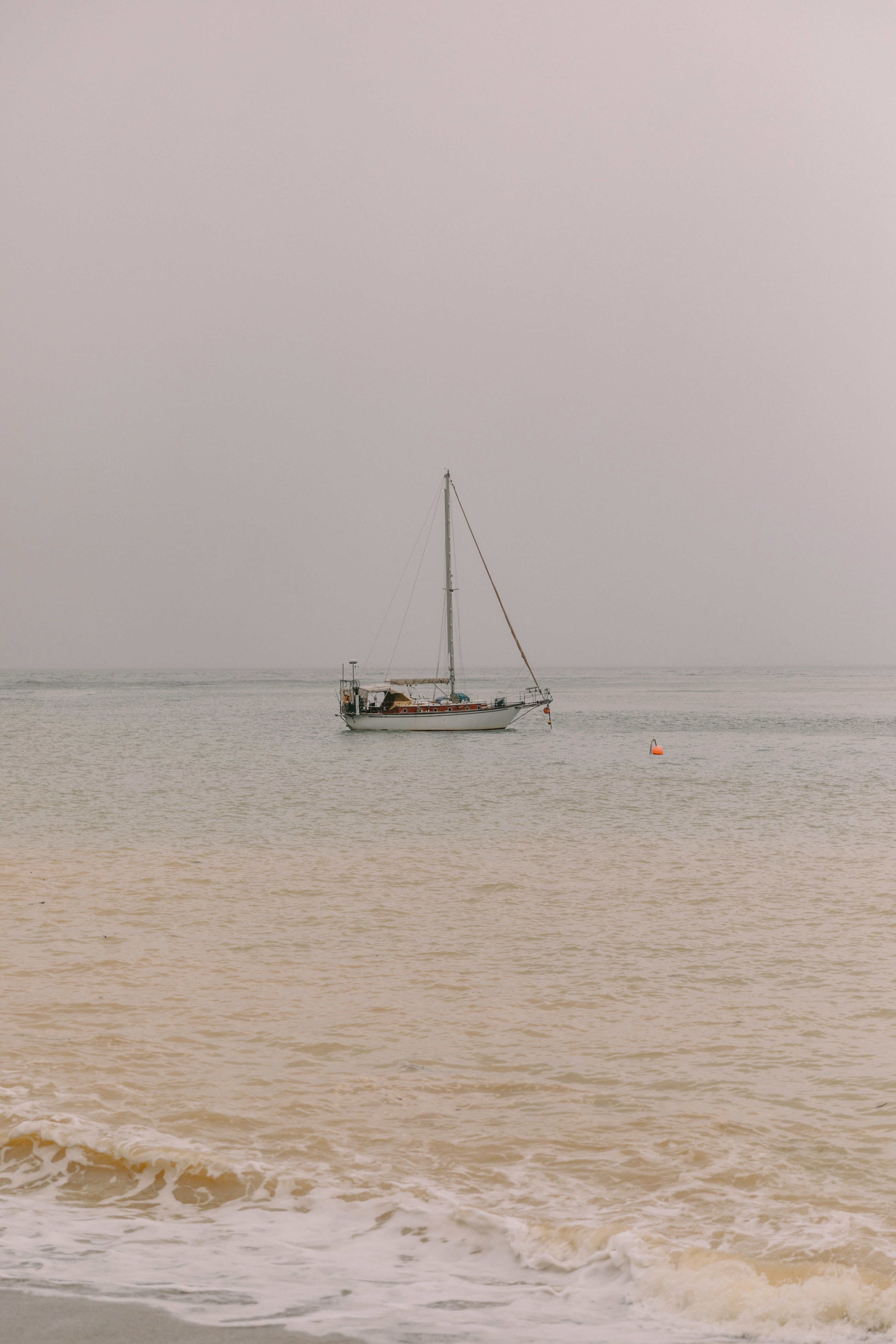 Sailing Solo: A Lonely Vessel Drifts on Quiet Seas