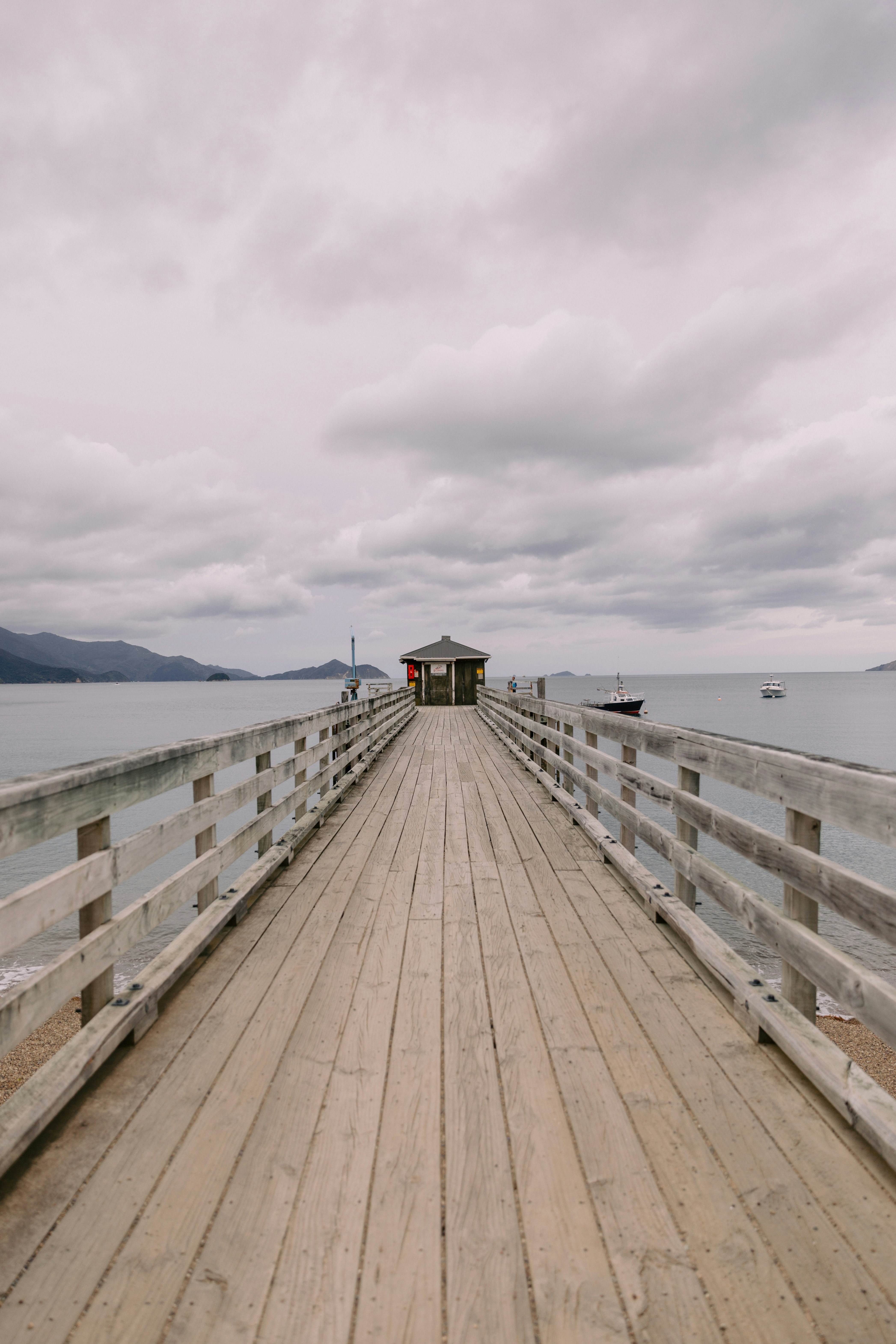 End of the Pier: A Wooden Path to the Small Structure