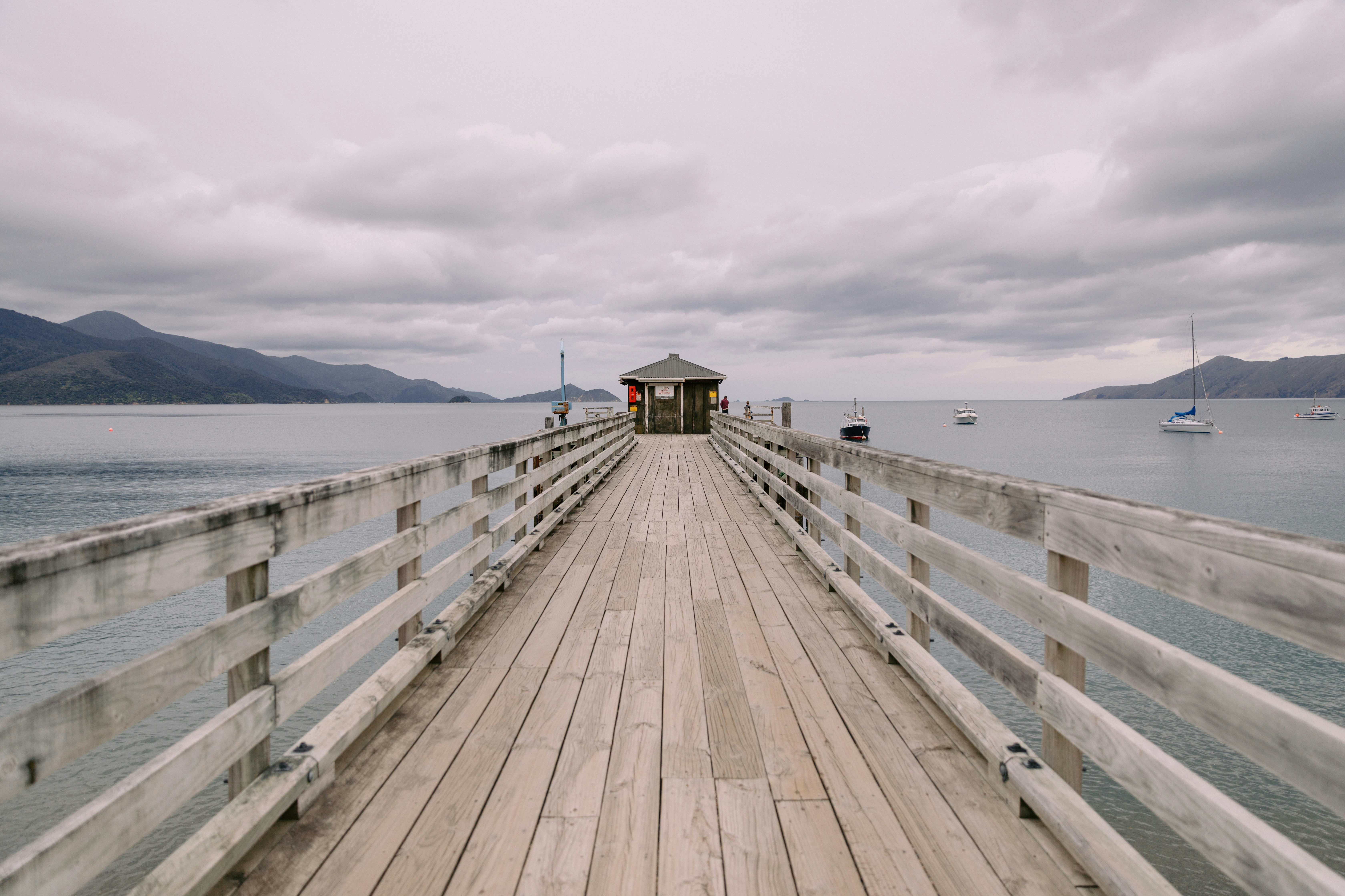 Pier to the Horizon: A Wooden Walkway Extends into Quiet Waters