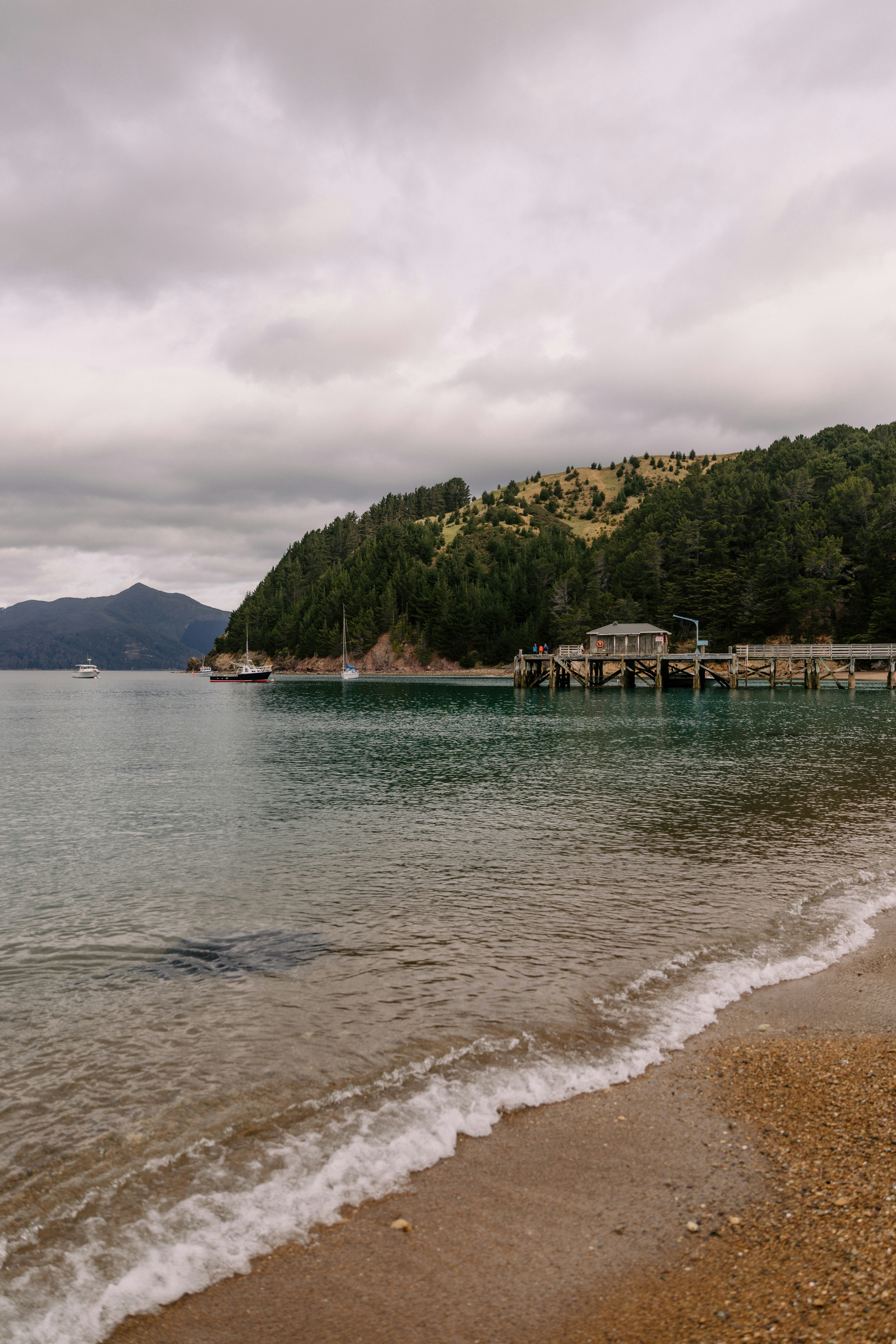Serene Lakeside Pier Beneath Clouded Skies