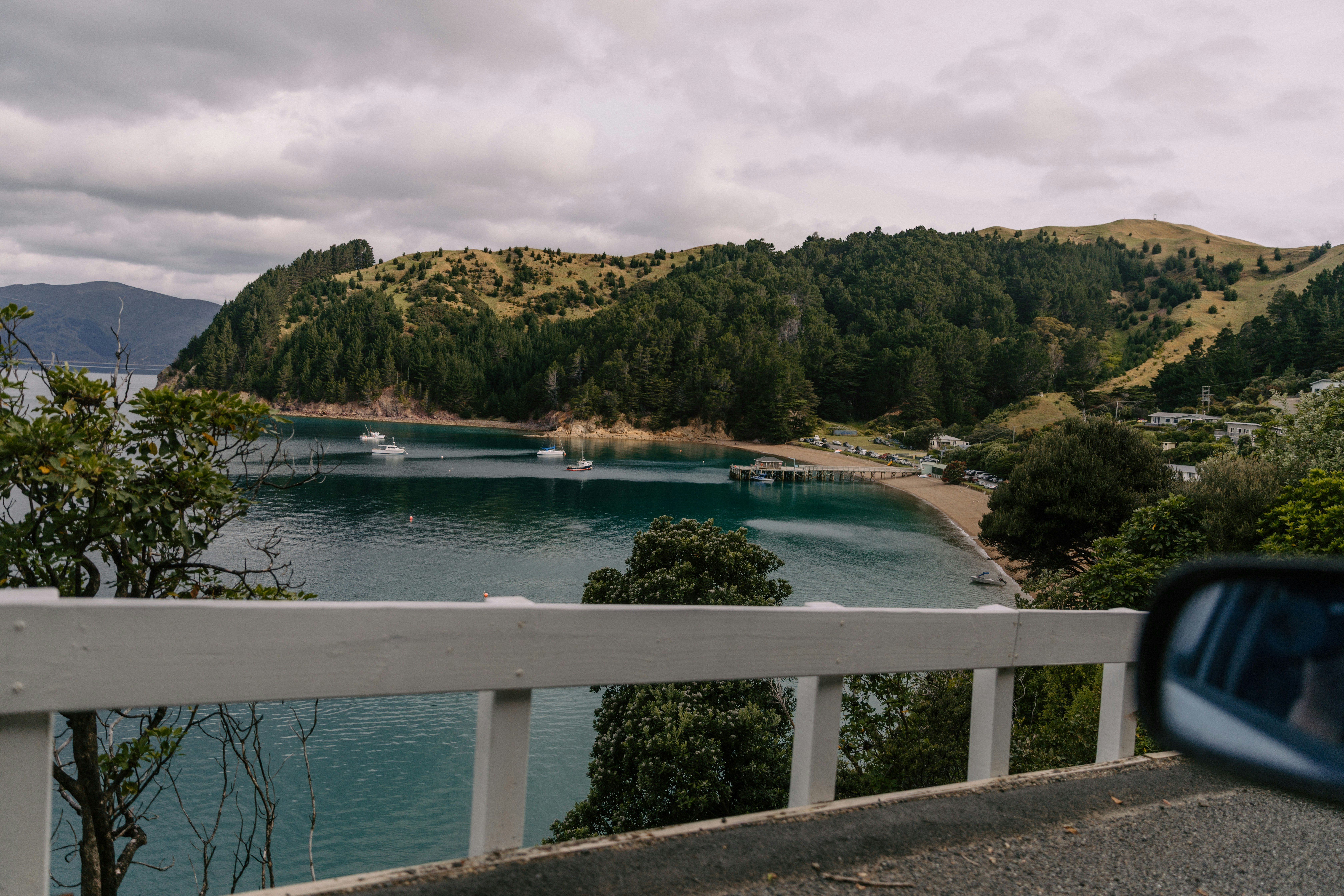 Coastal cove beneath a roadside railing