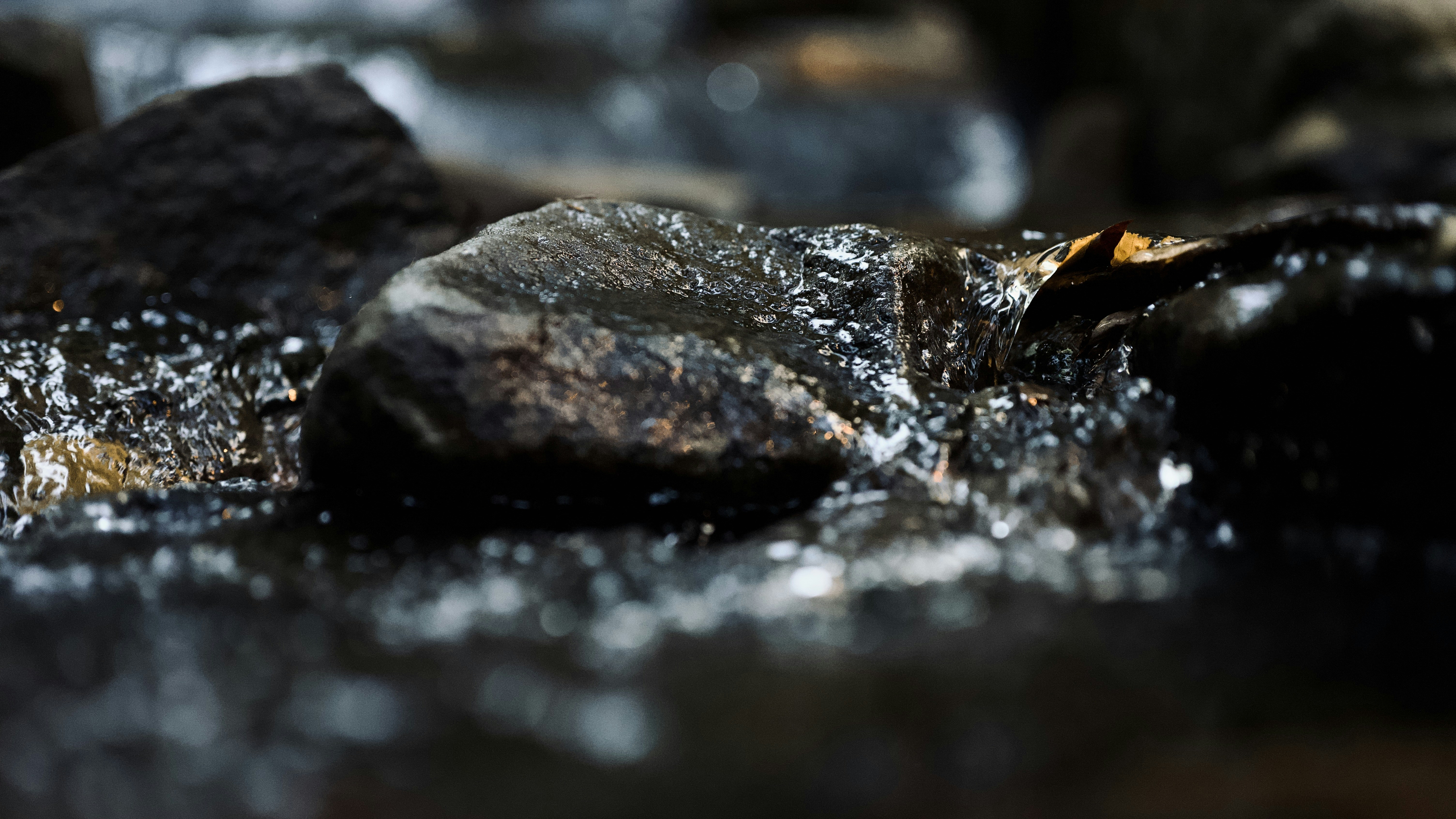 Glacial Pebbles Under a Shimmering Stream