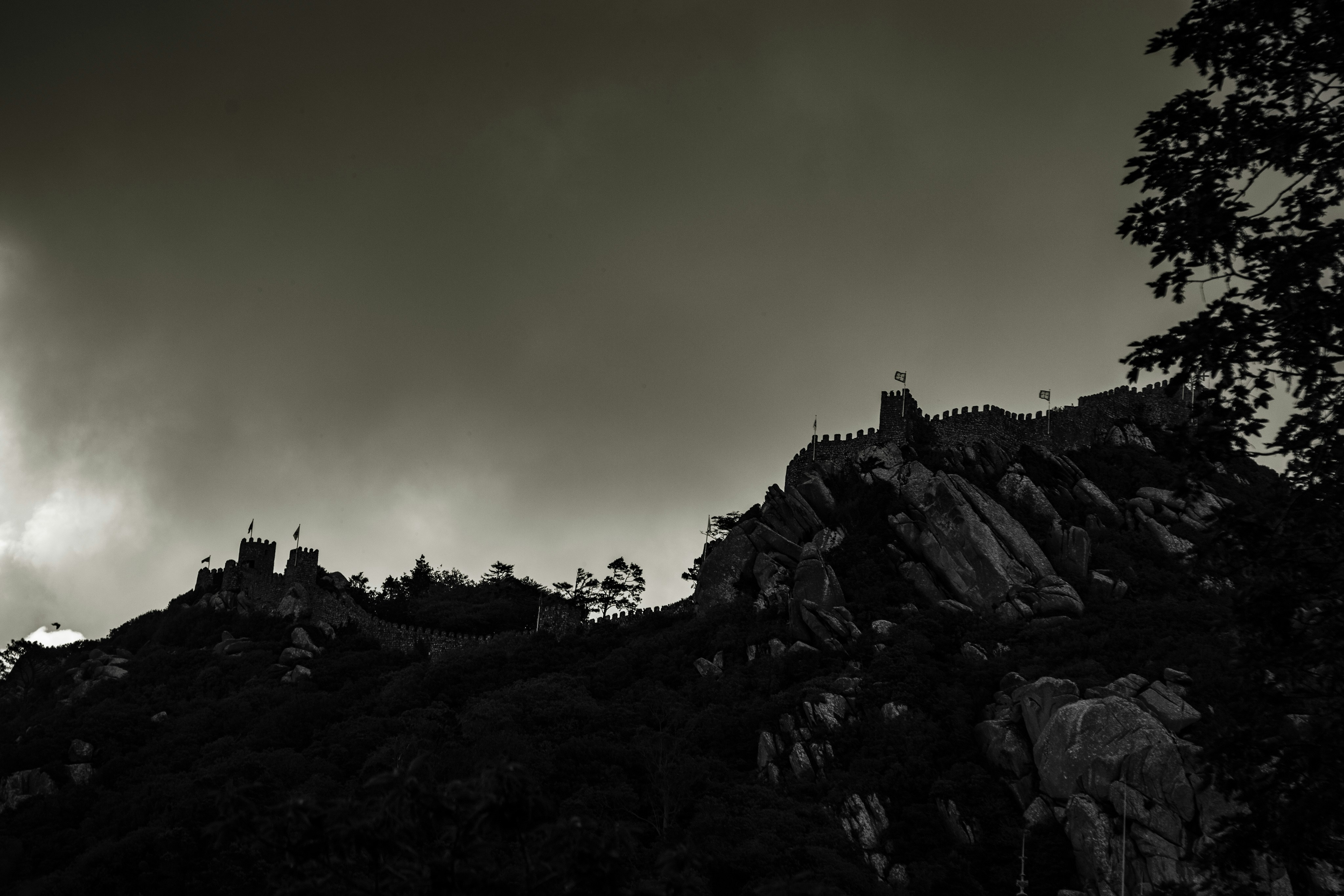 Fortress on the Ridge: A Dark Silhouette Against Mountaintop Skies
