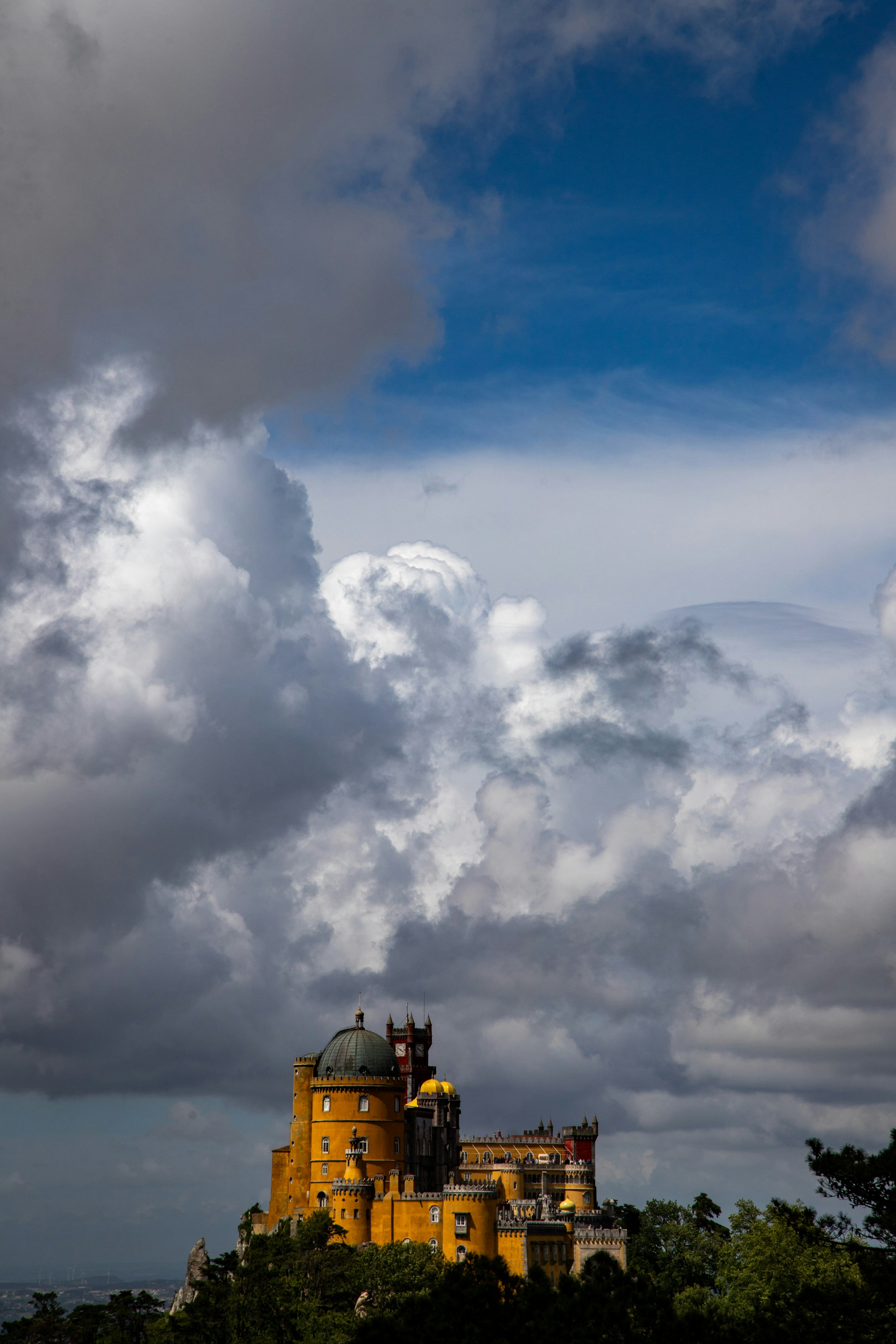 Castle on the Cliff: Golden Walls Beneath Stormy Skies