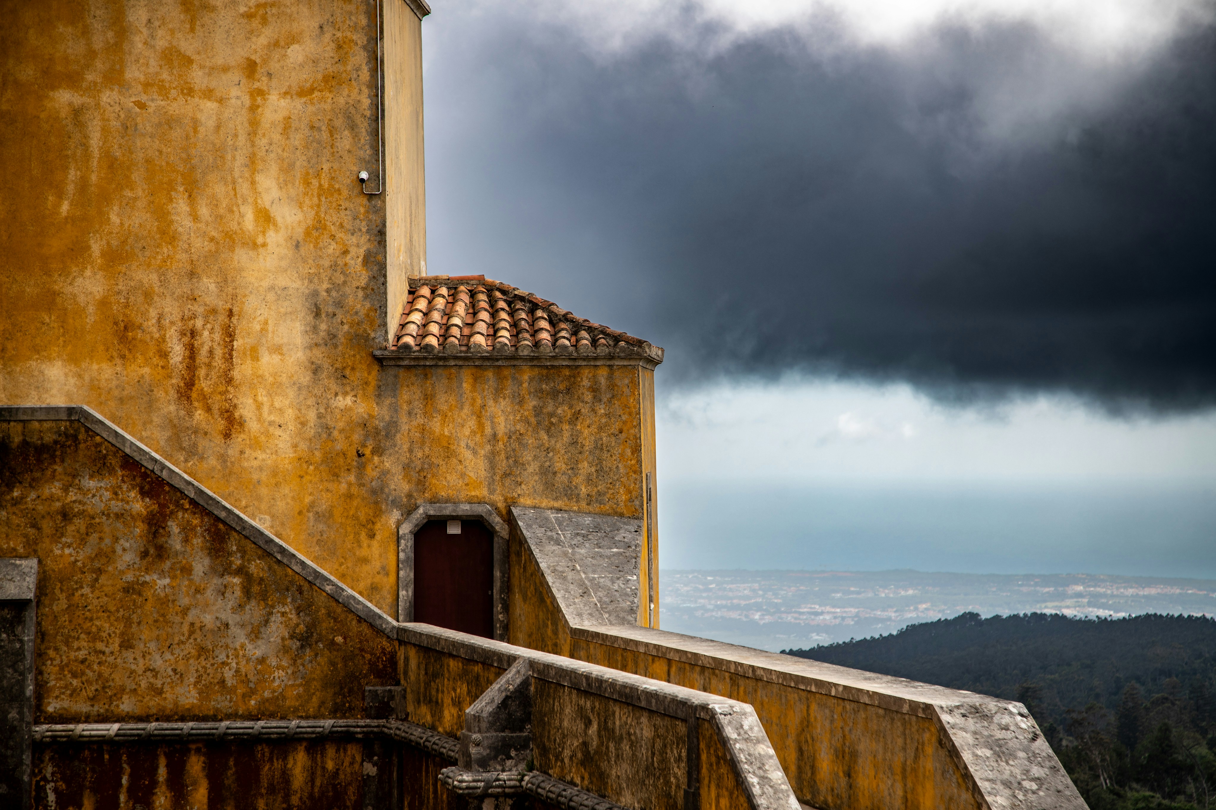 Sunlit Terracotta Facade Against a Stormy Horizon