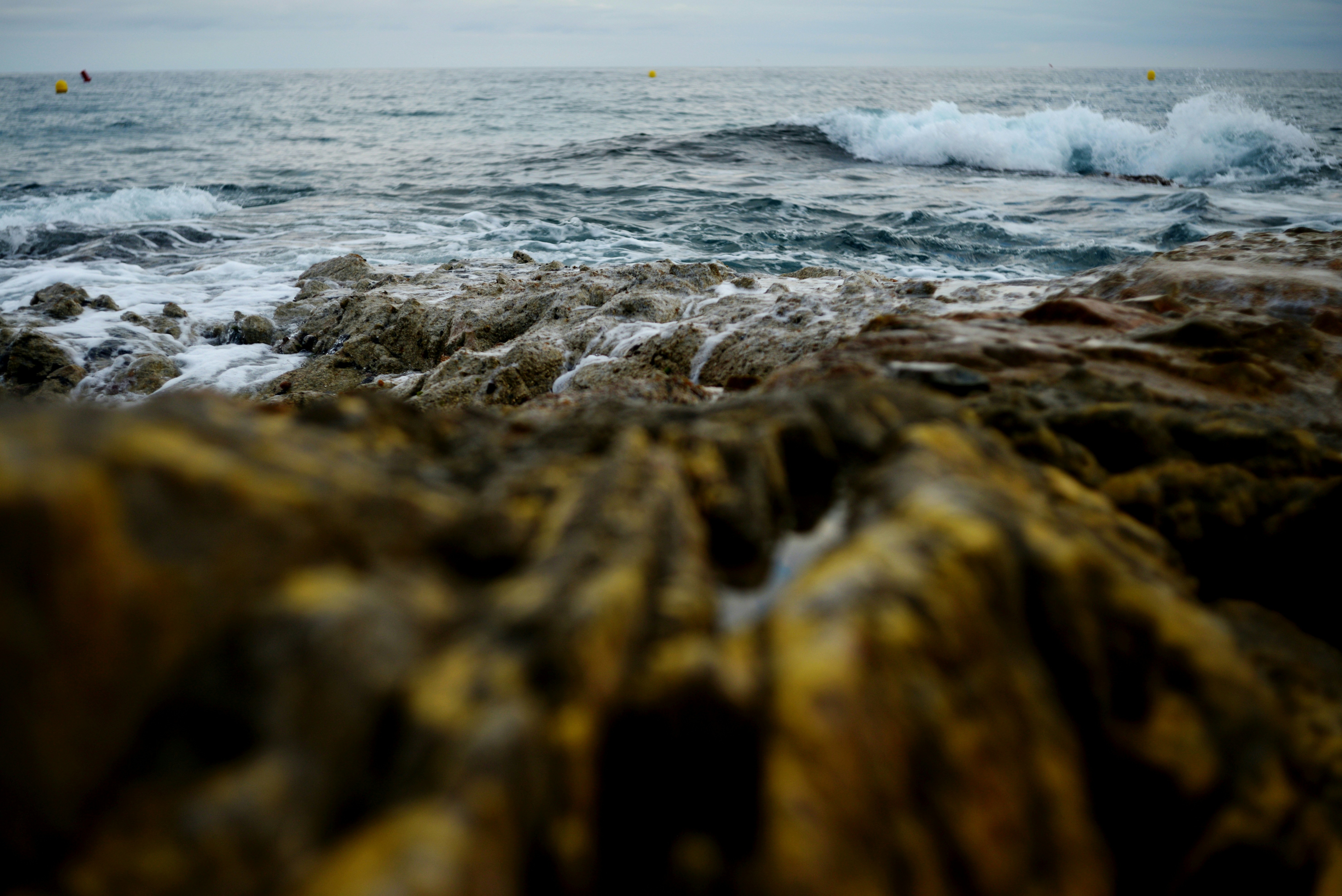 Rugged Tide: A Low-Angle Rock Face Meets Quiet Ocean