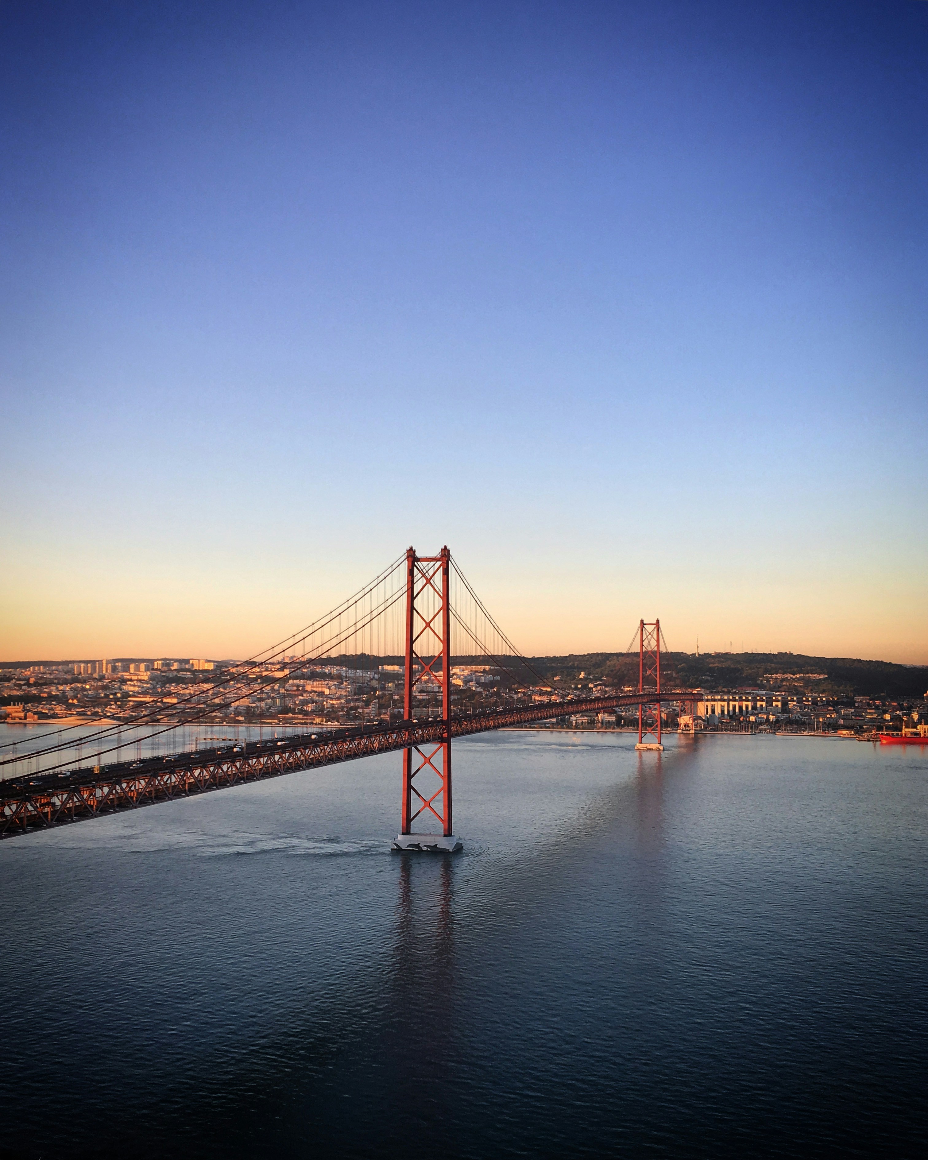 Aerial Vista: The Steel Spine of a Coastal Bridge at Sunset