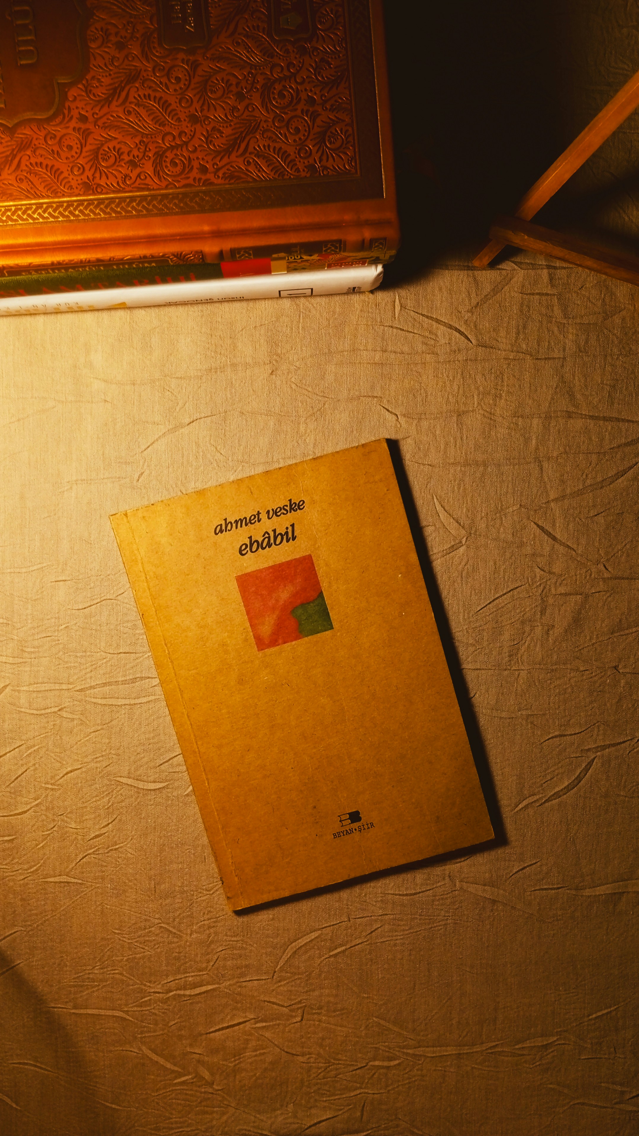 Amber-Themed Still Life: A Lone Book on Textured Linen