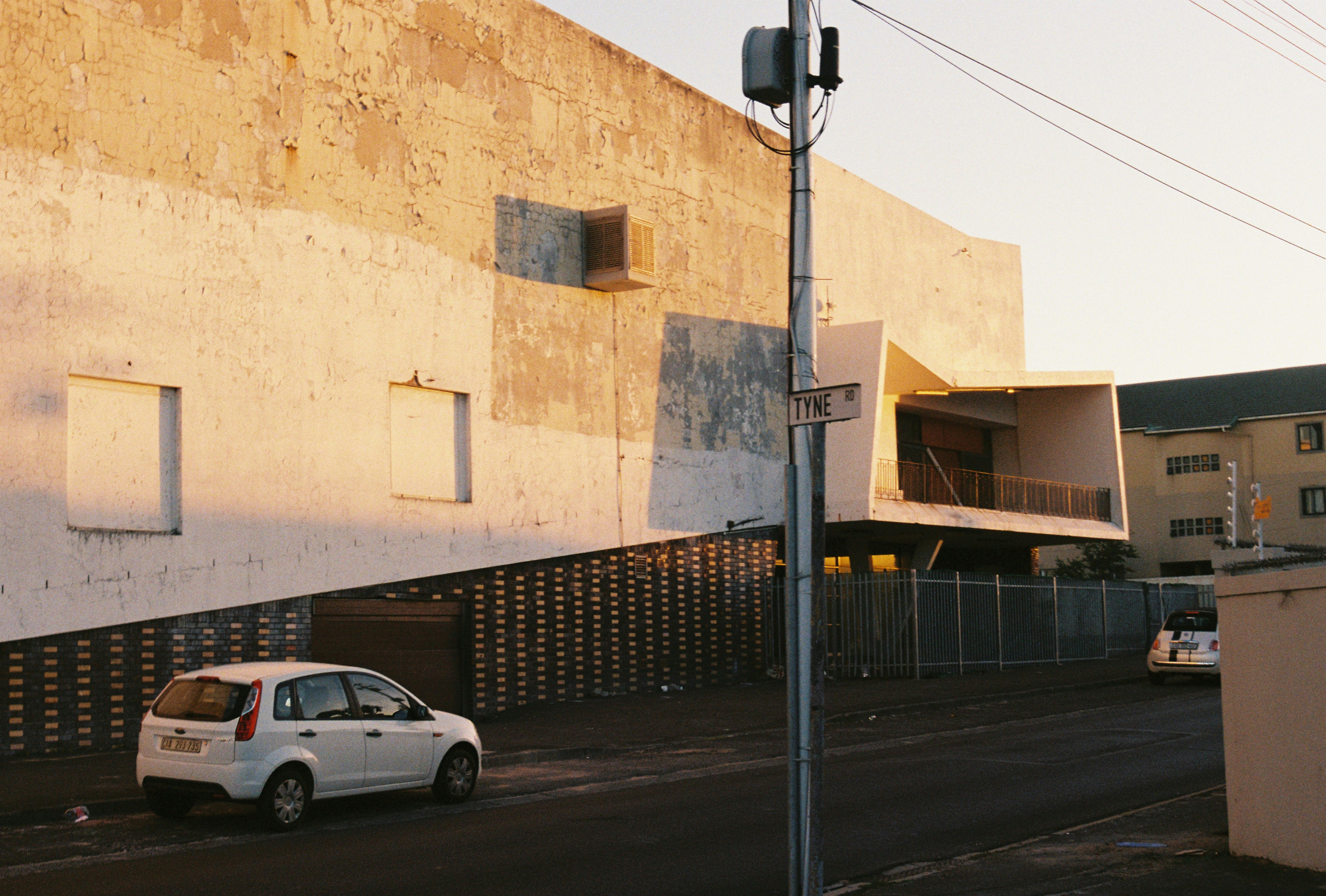 Sunlit Street Bass: A Quiet Corner by the Deserted Building
