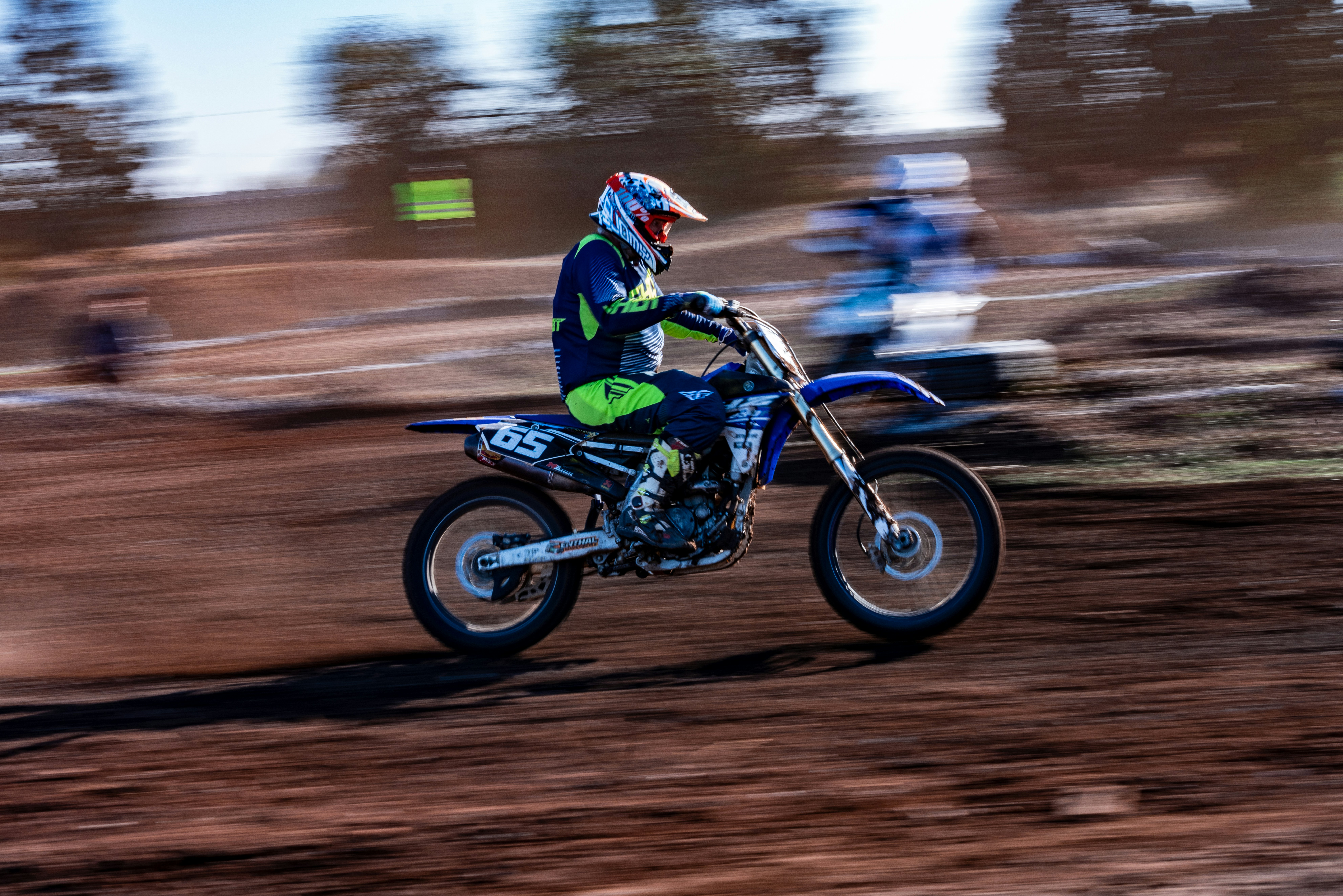 Blurred Velocity: A Motocross Burst Across Burnt Clay