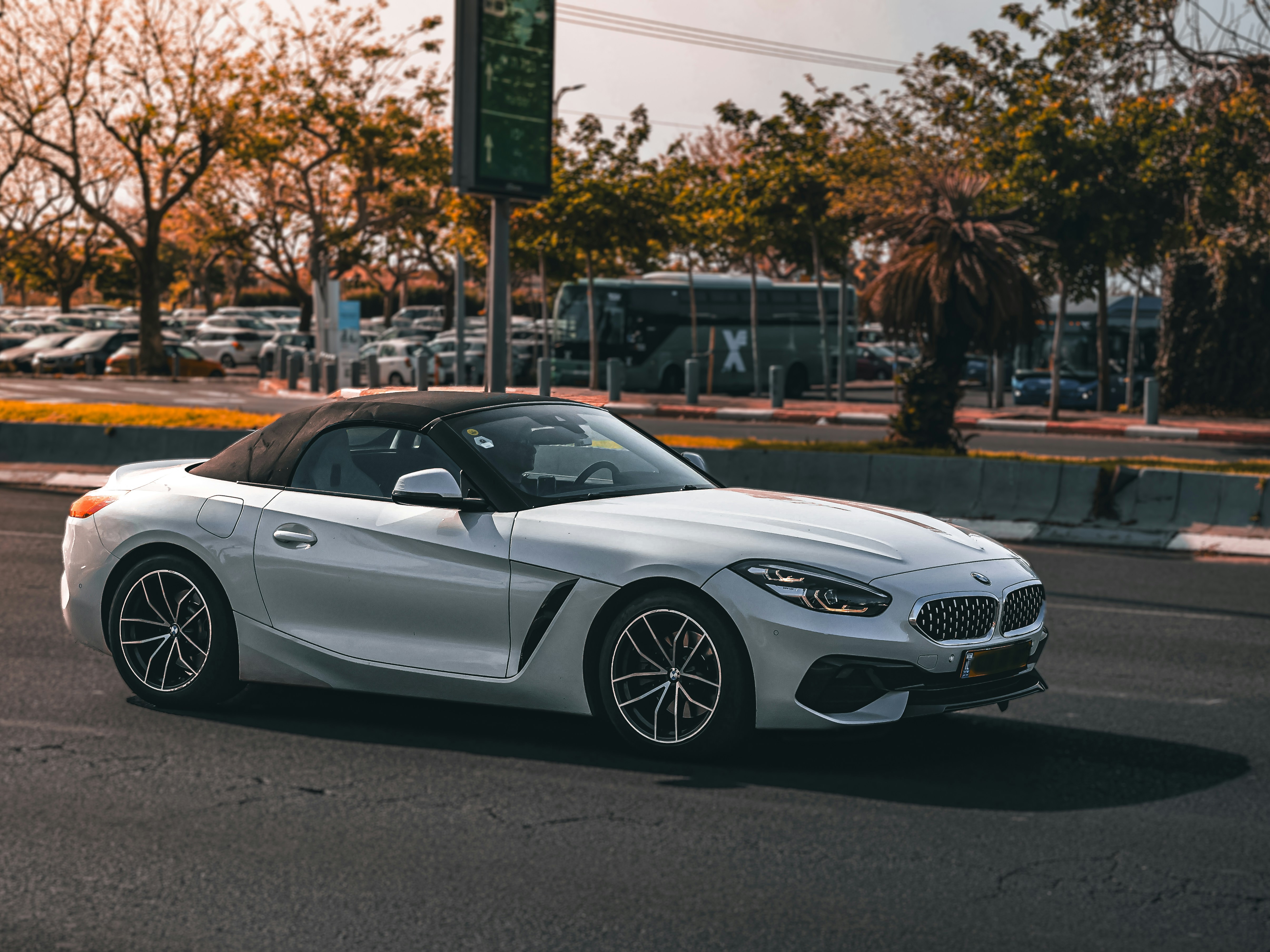 White Convertible Stance: A Street-Ready BMW Gliding Under Autumn Light