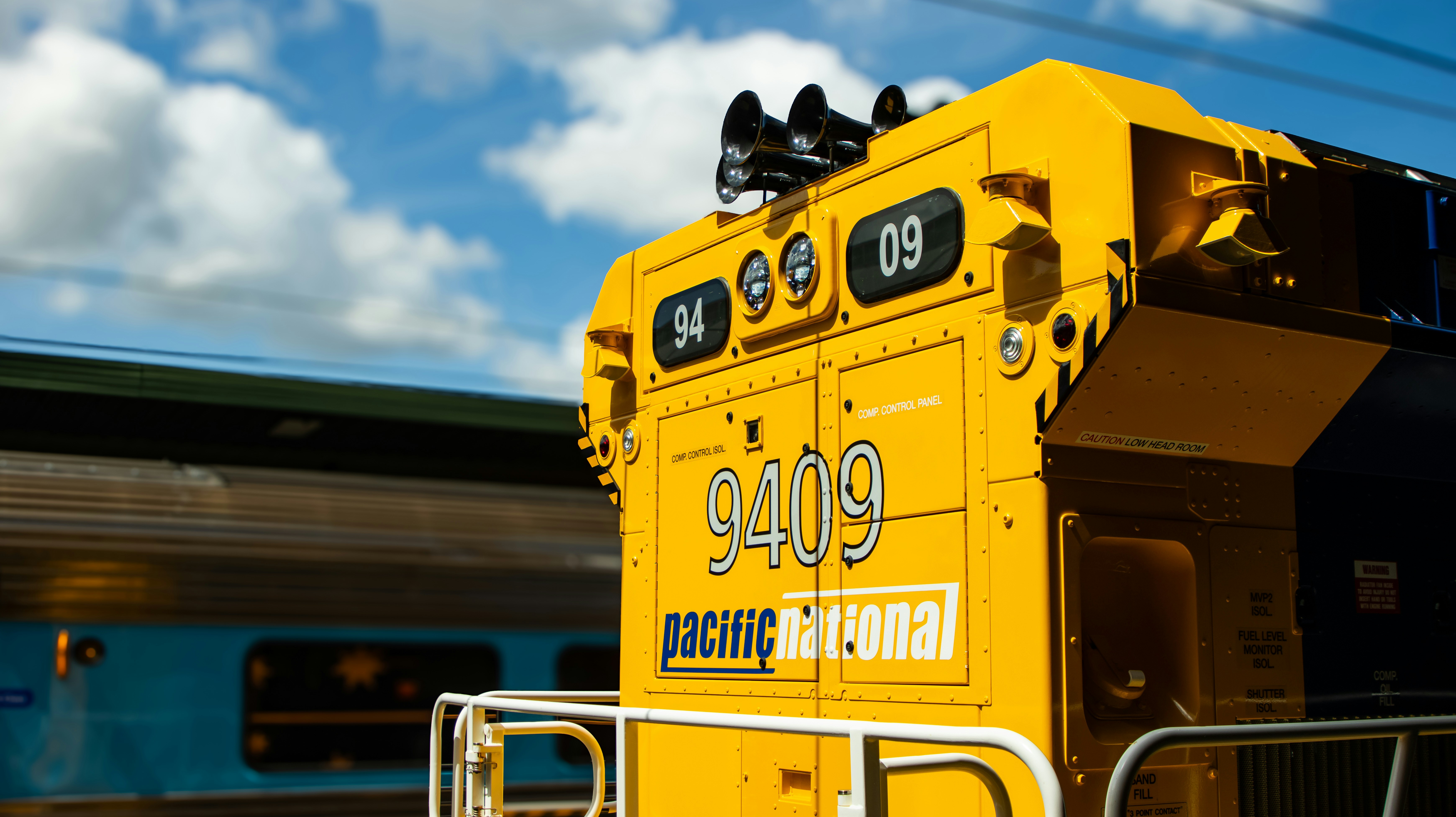 Yellow locomotive in motion: the heart of the yard bursts through the frame