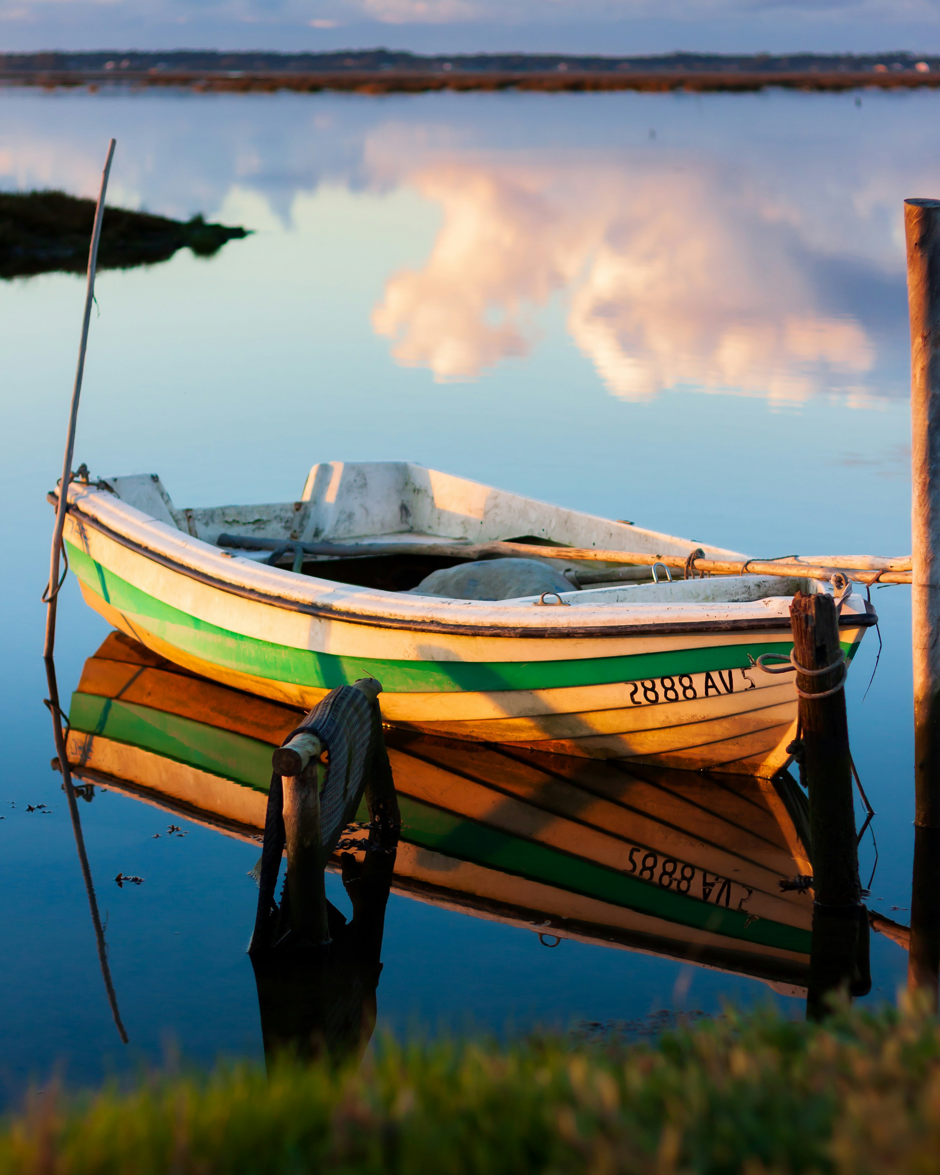 Colorful Beached Rowboat Mirror on Quiet Water