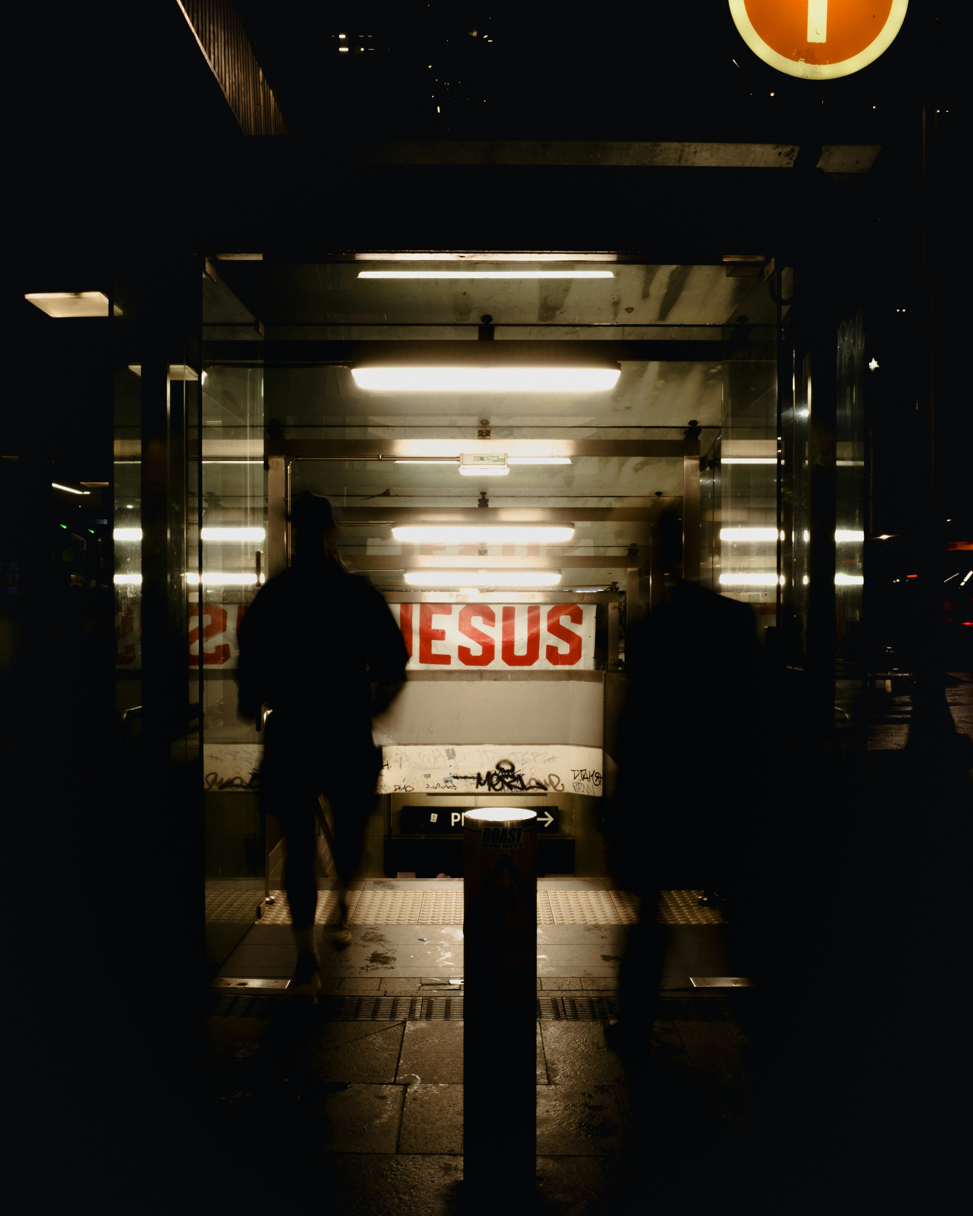 Ghosts of the Metro: Jesus on a Neon Sign Behind the Doorway