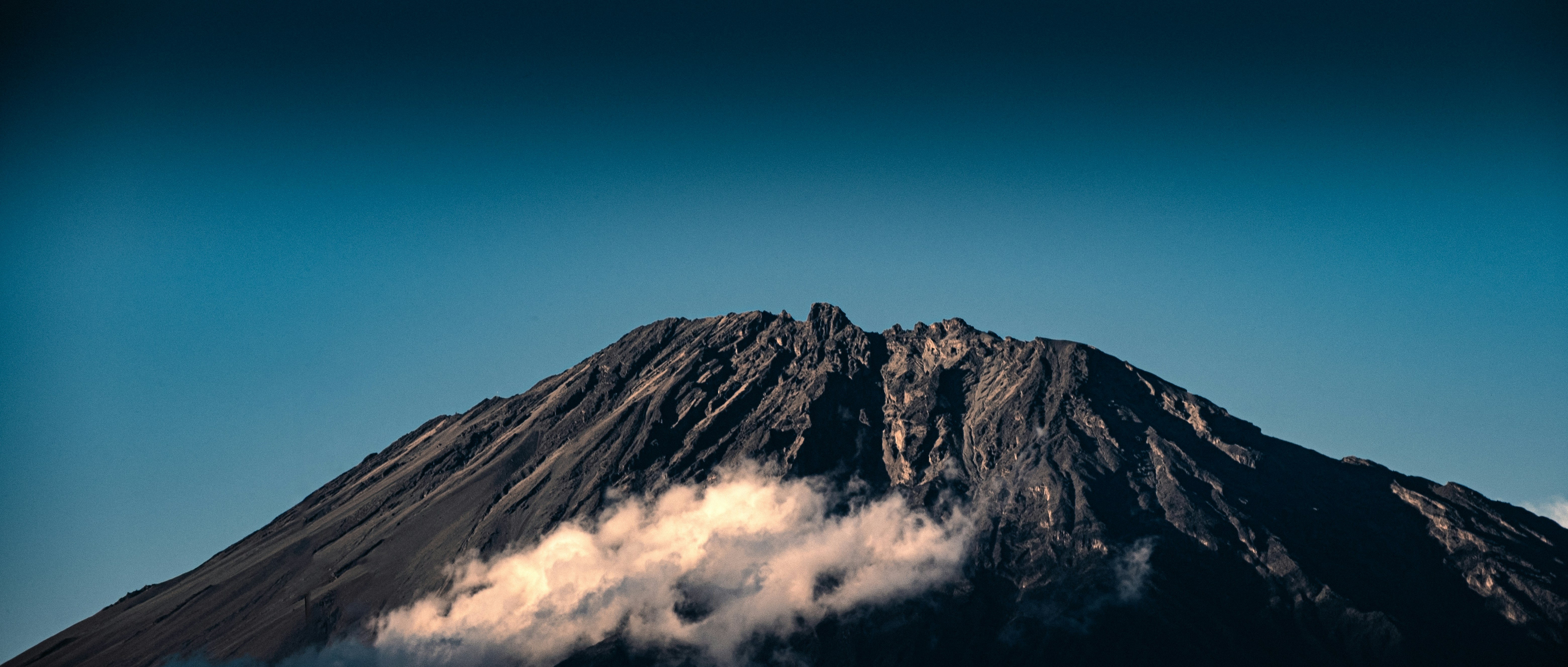 Cloud-kissed Summit under a Crisp Alpine Sky