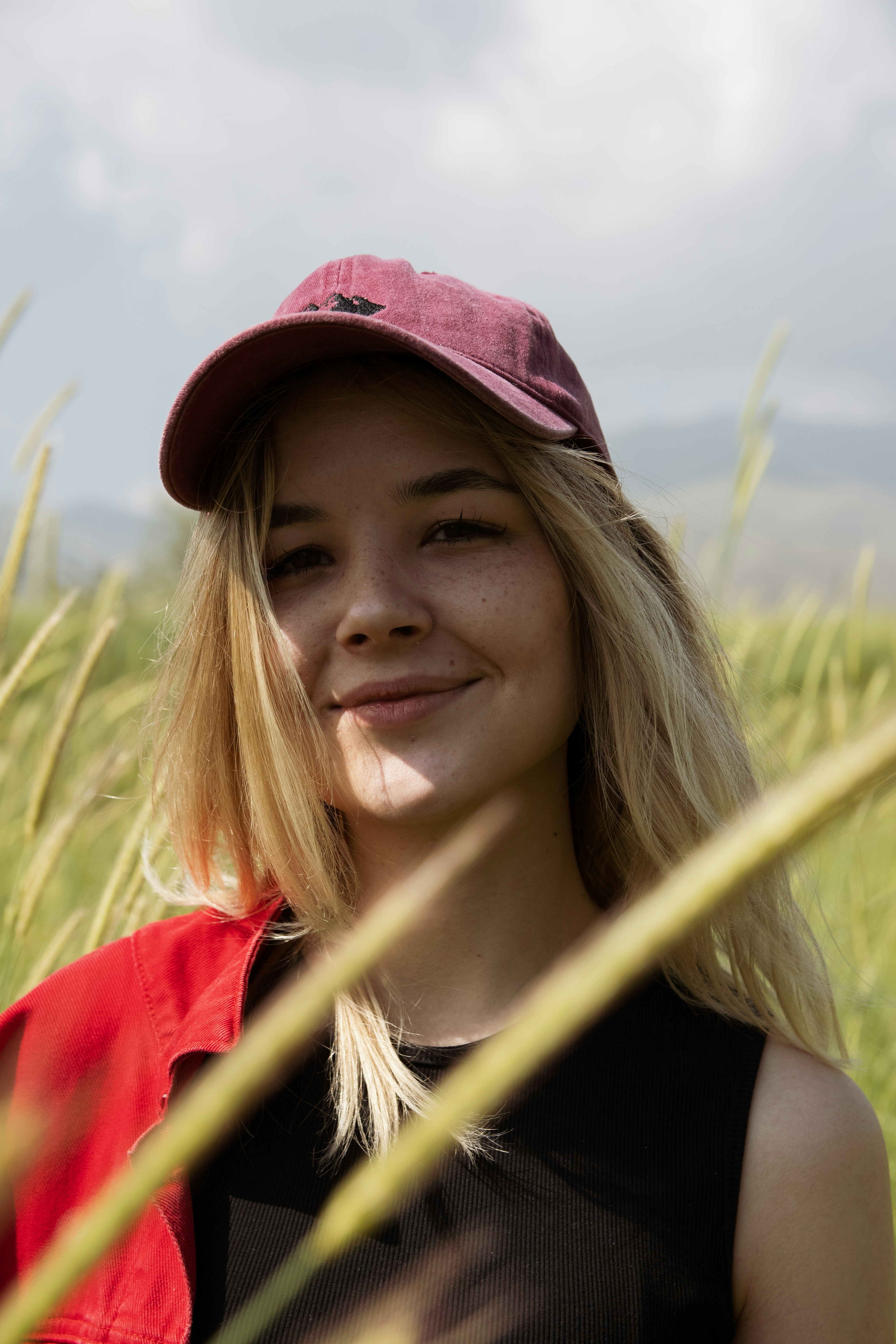 Sunlit Grin: A Portrait Amid Golden Field Grass