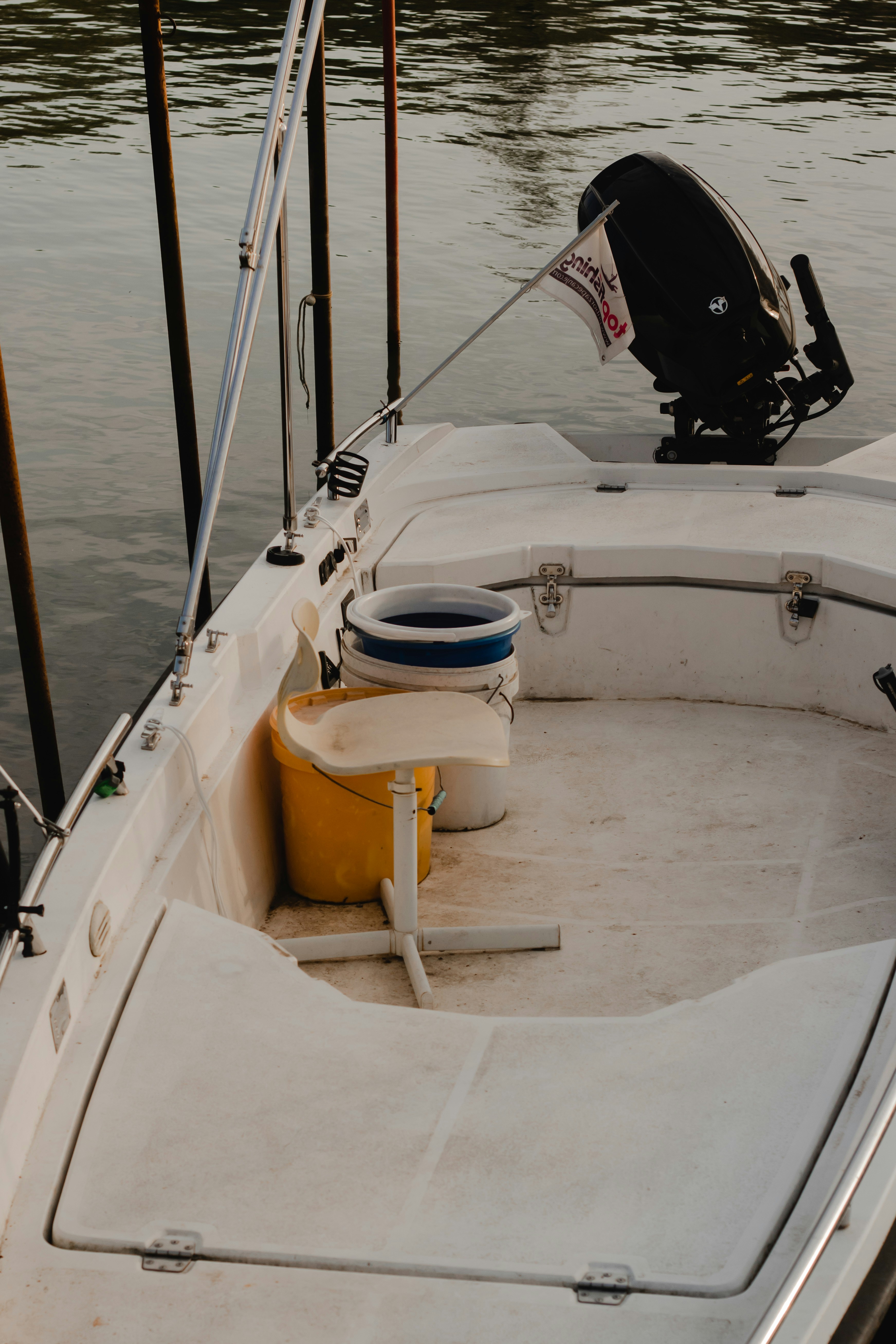 Sunlit Bow of a Fishing Boat with Tidy Deck and Outboard
