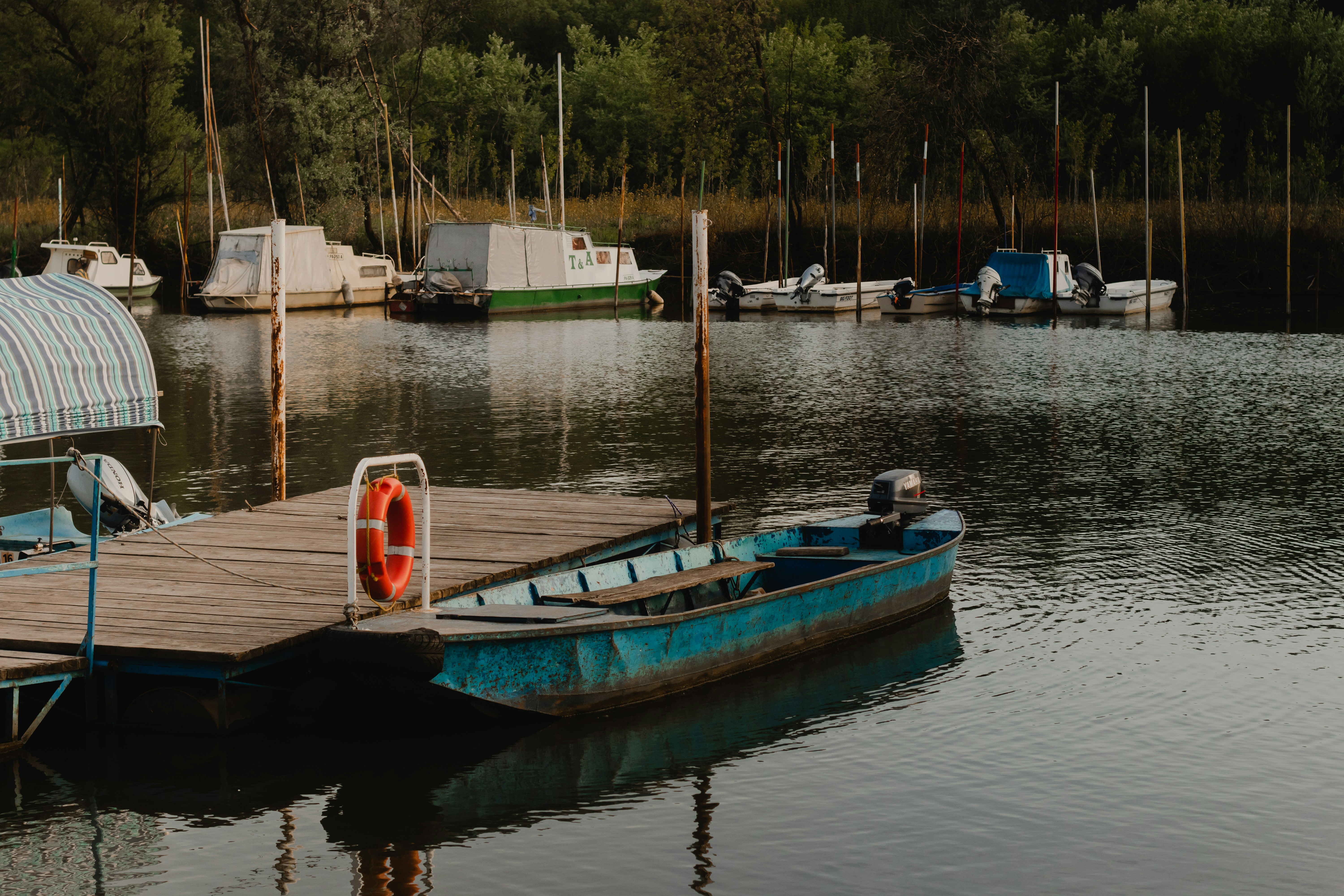 Blue Boat at Quiet Pier in a Calm Marina