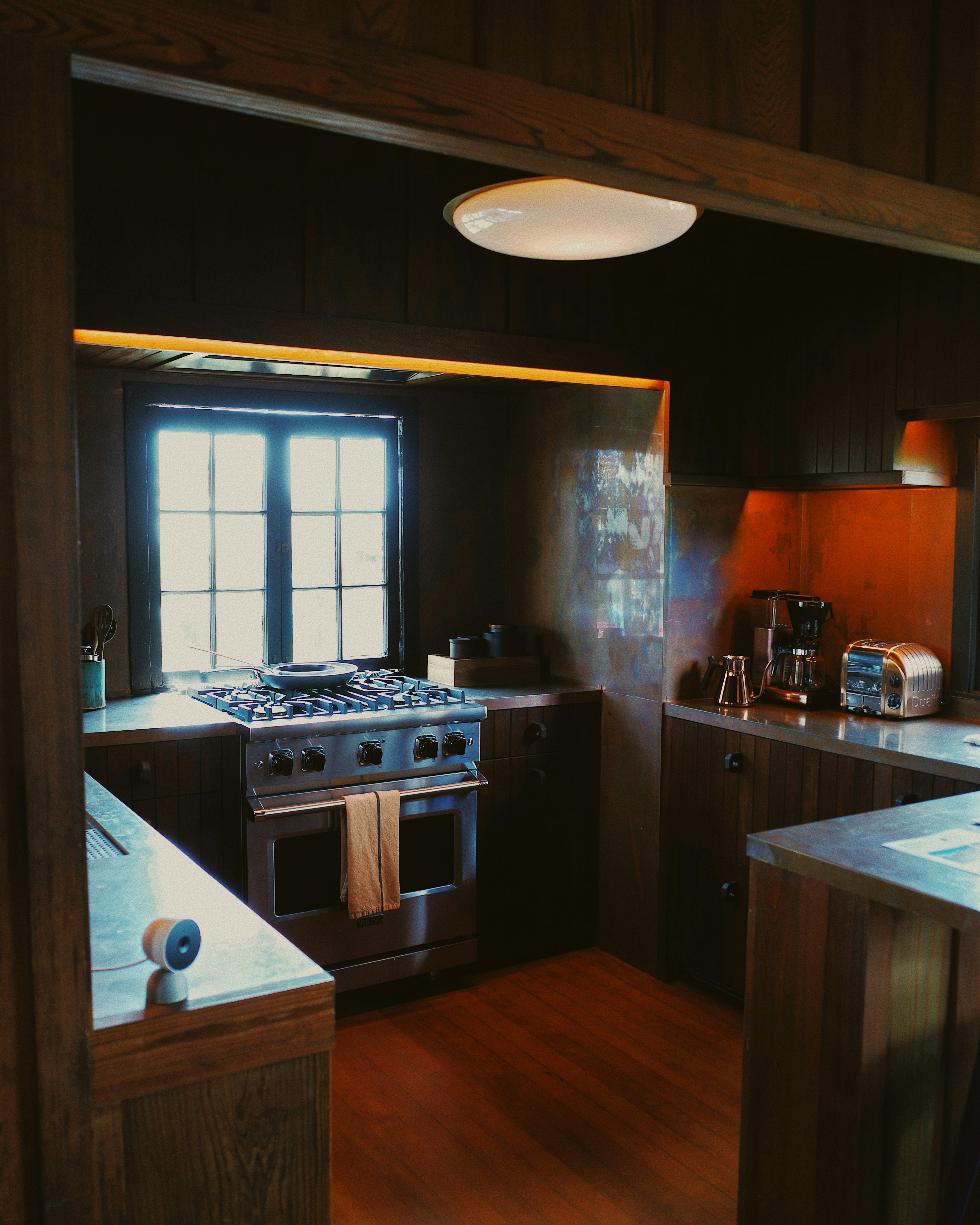 Warm Wood Kitchen with Stainless Stove under Soft Window Light